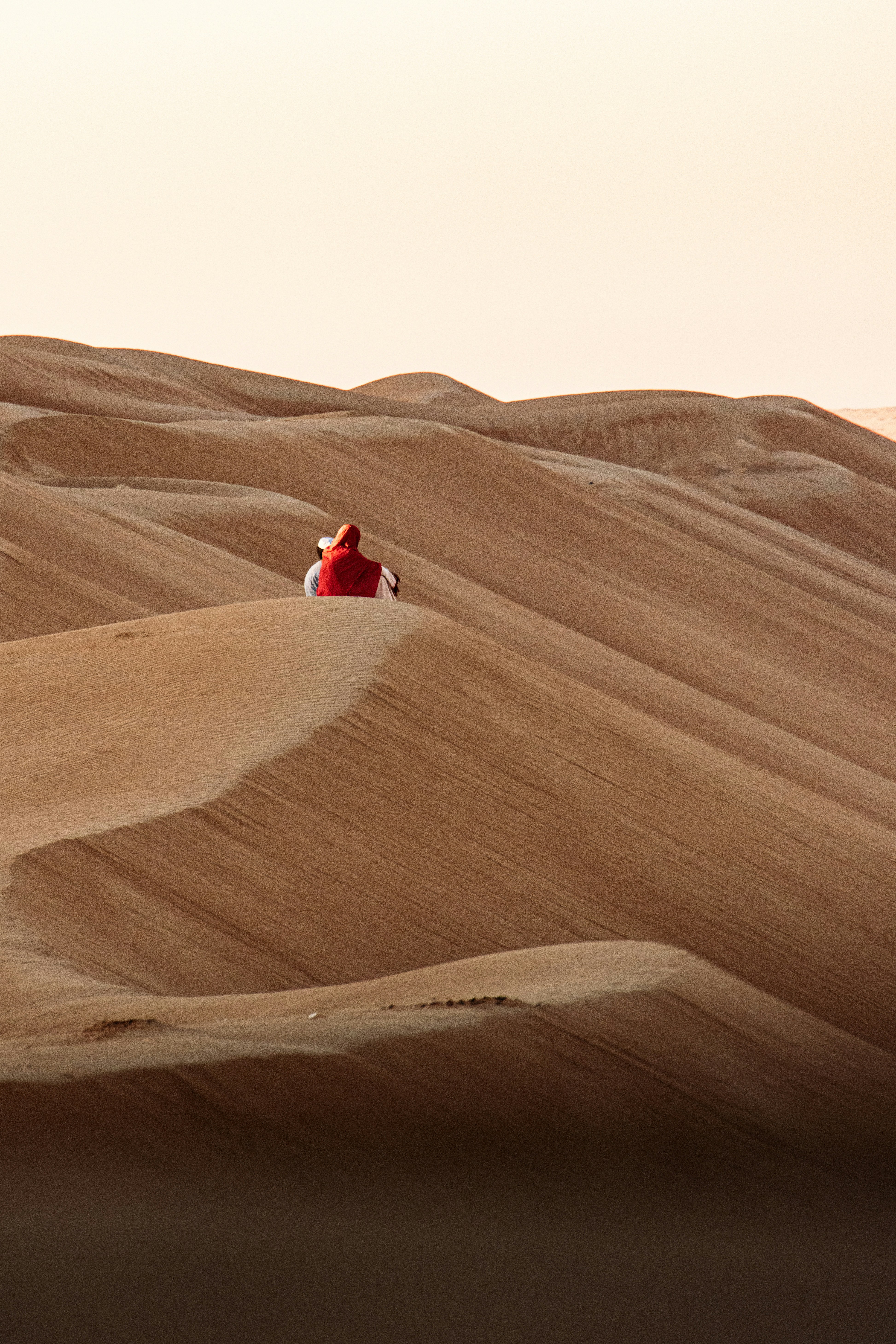 Desert Dune Silhouette: A Lone Explorer on the Crest