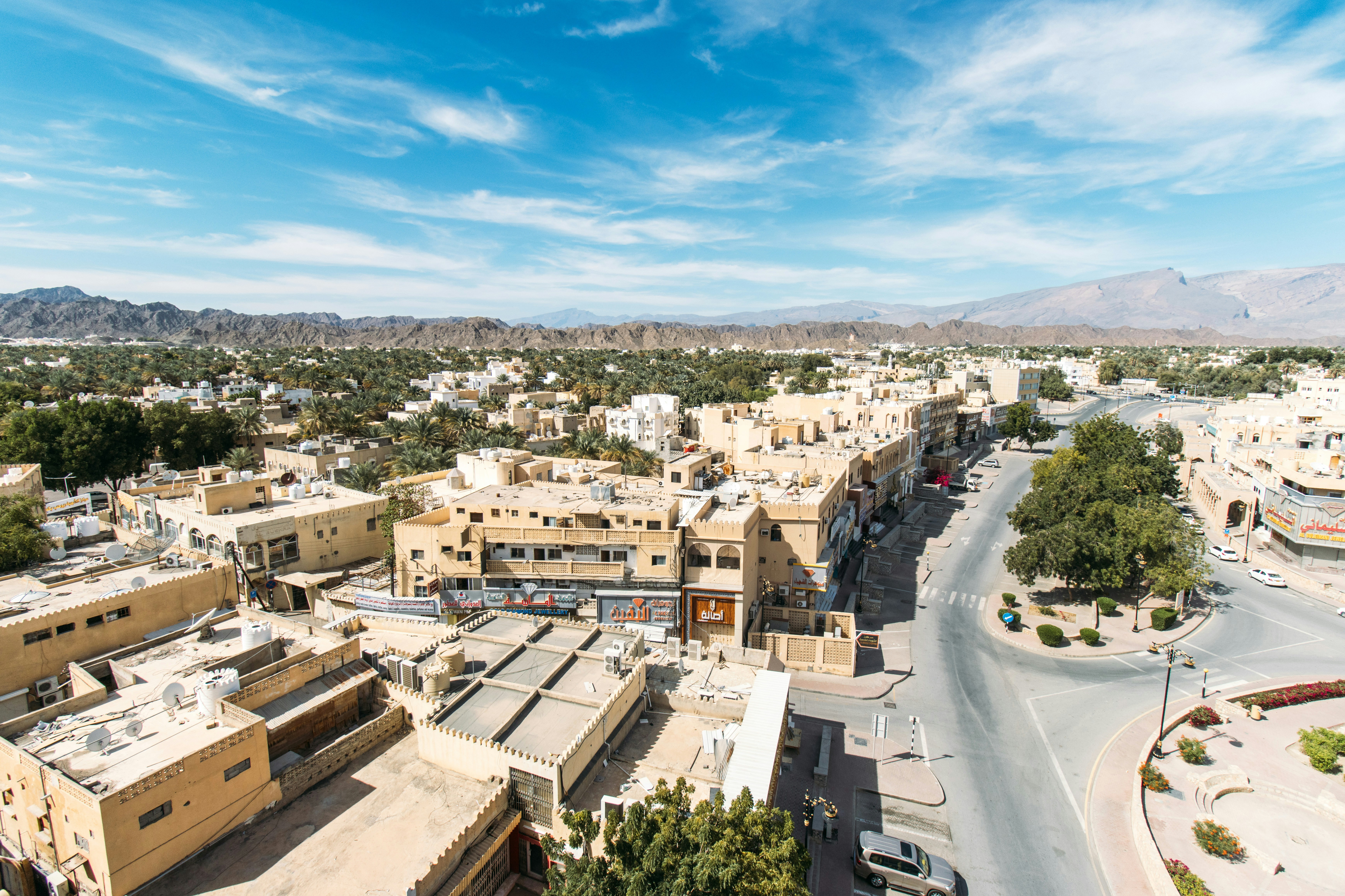A sunlit desert town unfolds from above