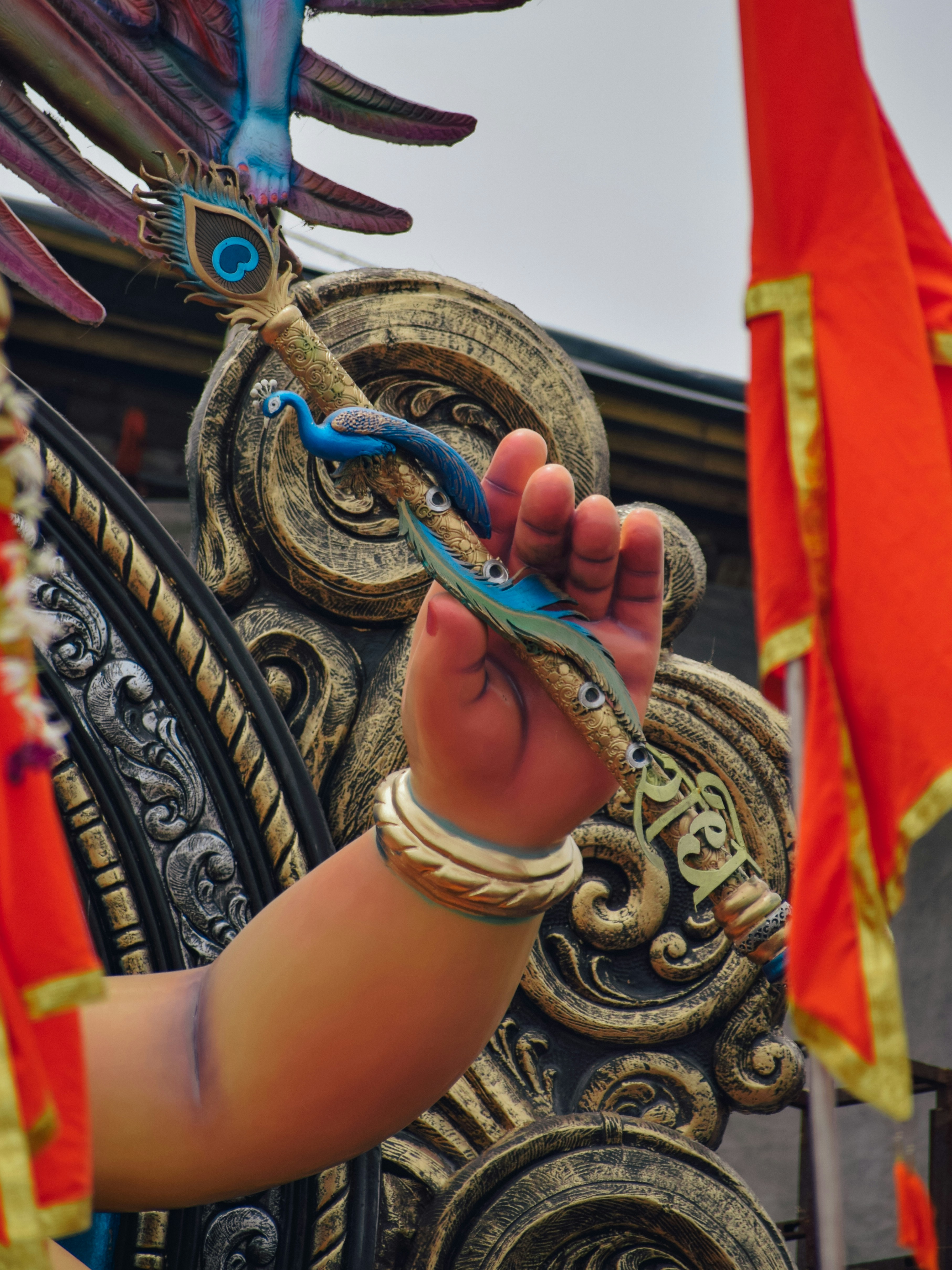 Hand and serpent: a ceremonial grip against carved brass