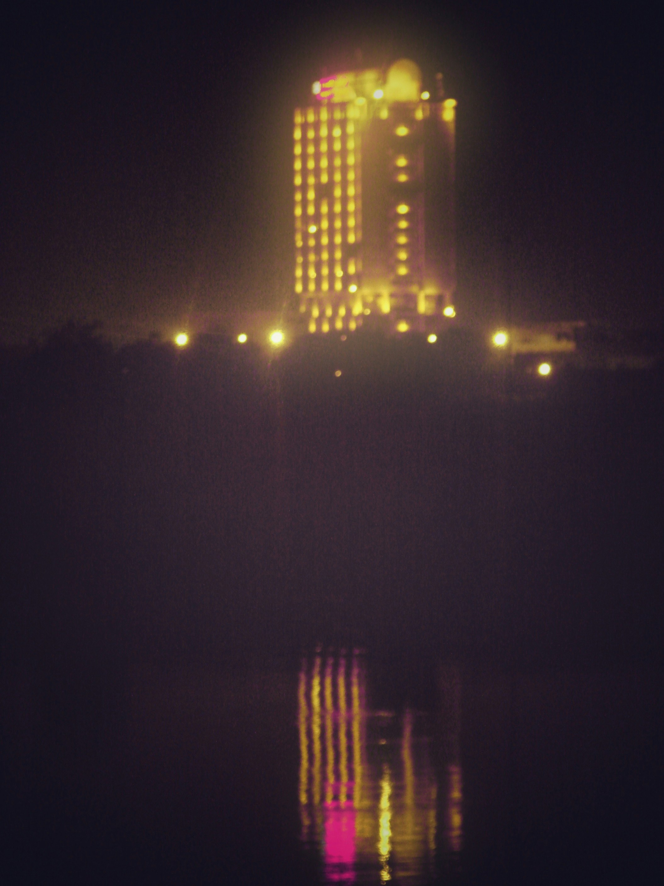 Luminous Highrise Across Quiet Water