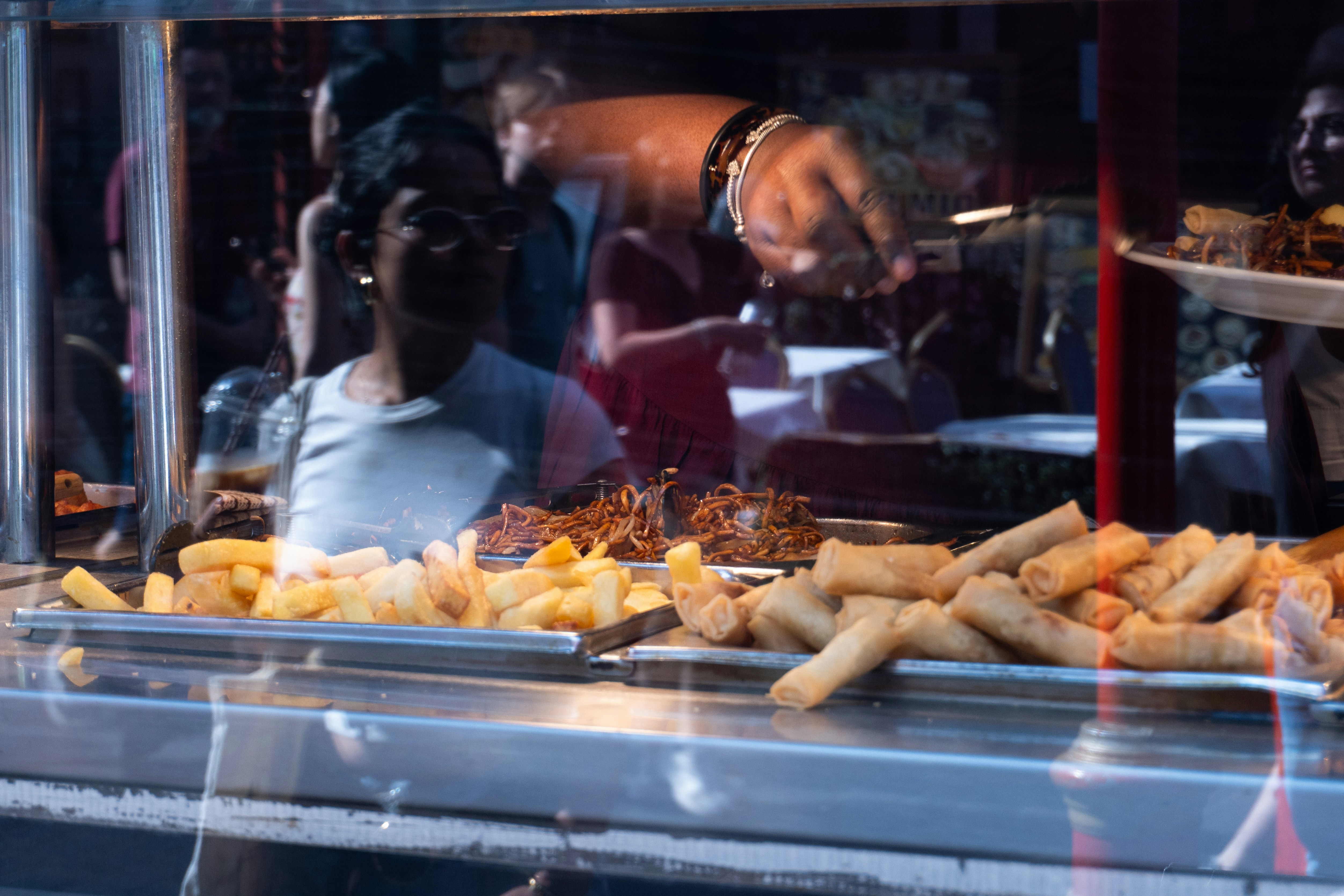 Frying Fingers and Fries: A Window into Street Snack Amid Night Reflections
