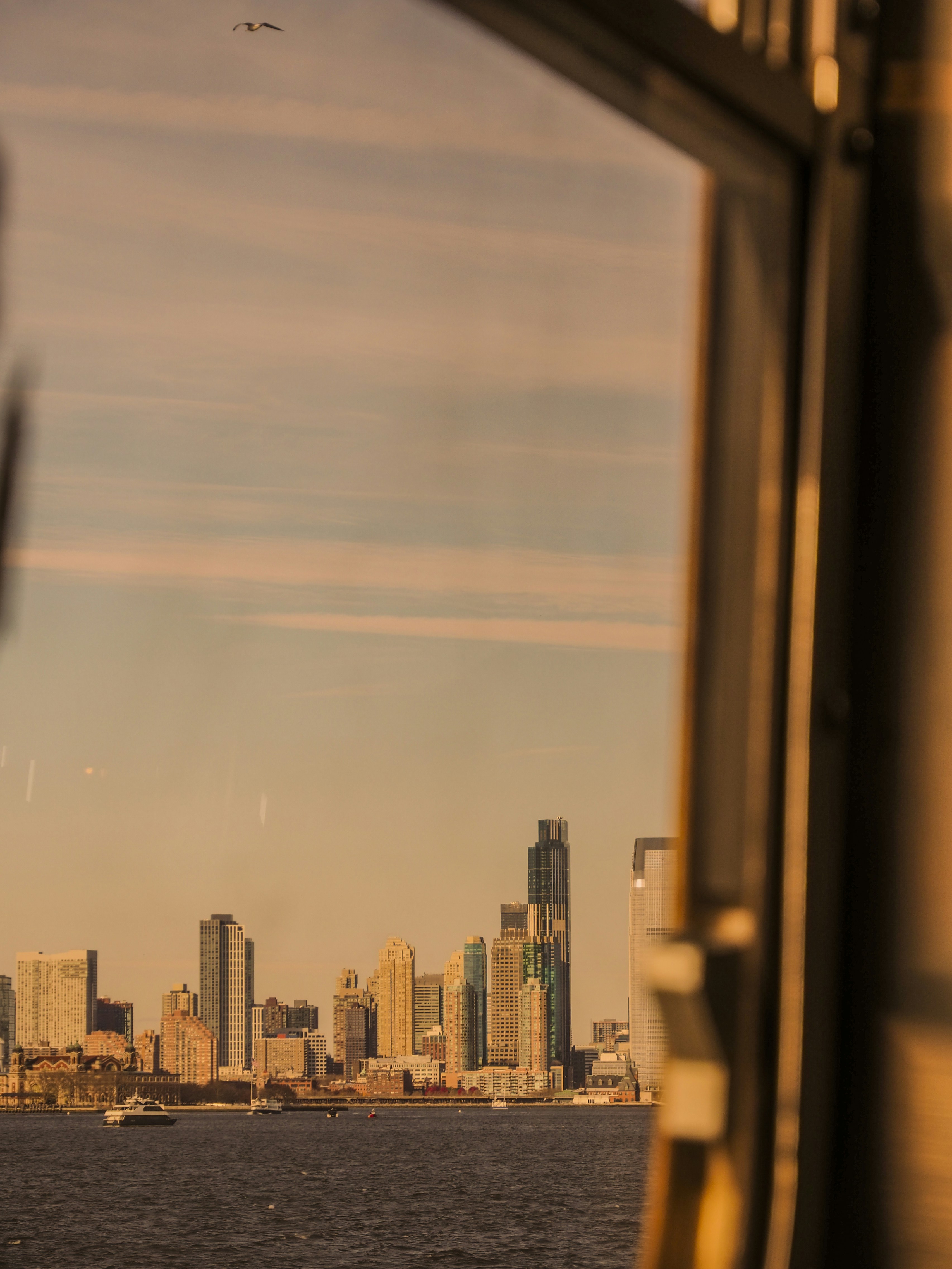 Golden Hour Skyline Framed by a Ferry Window