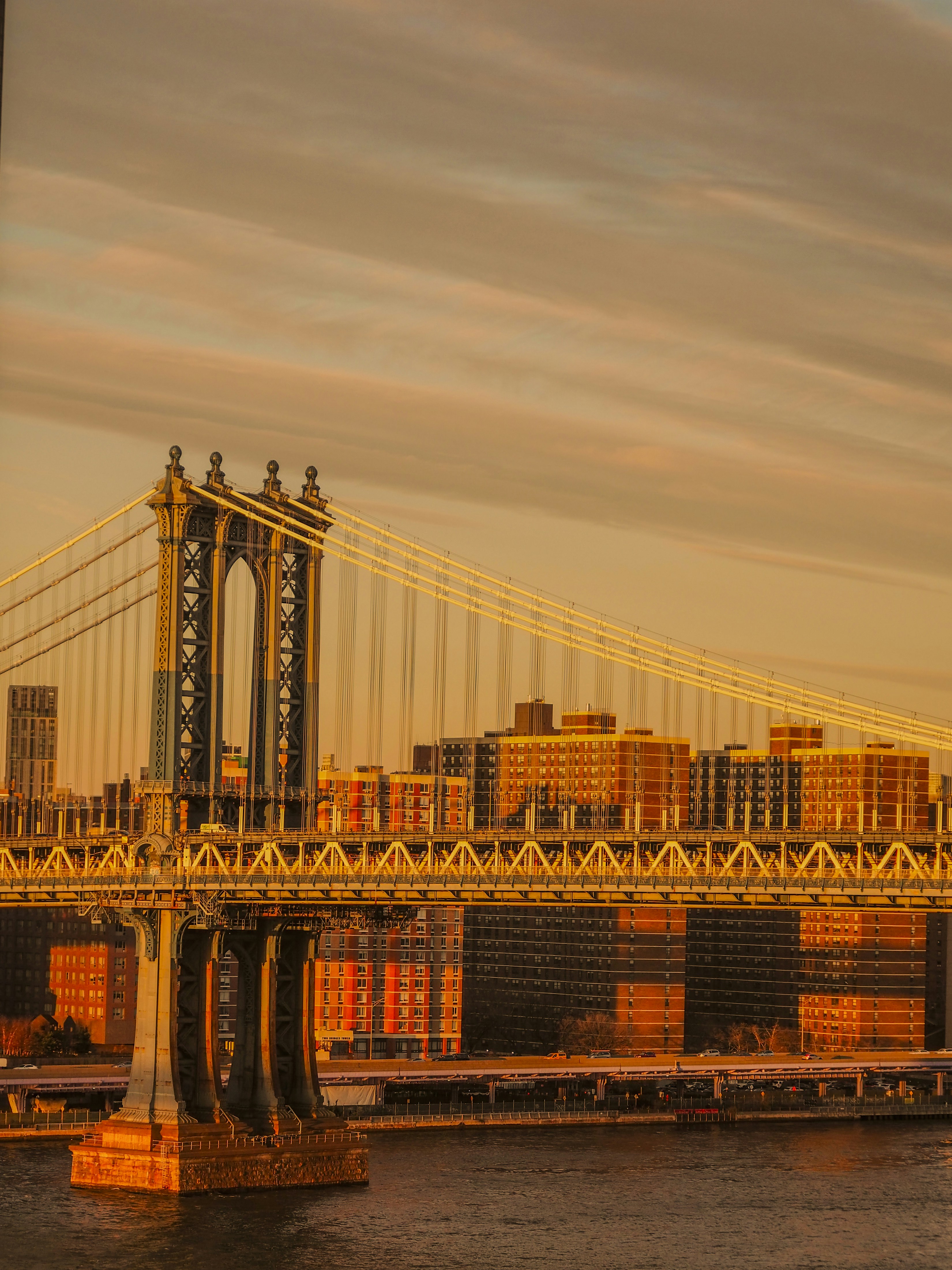 Golden Hour Suspension: Brooklyn Bridge and Skyline in Warm Light