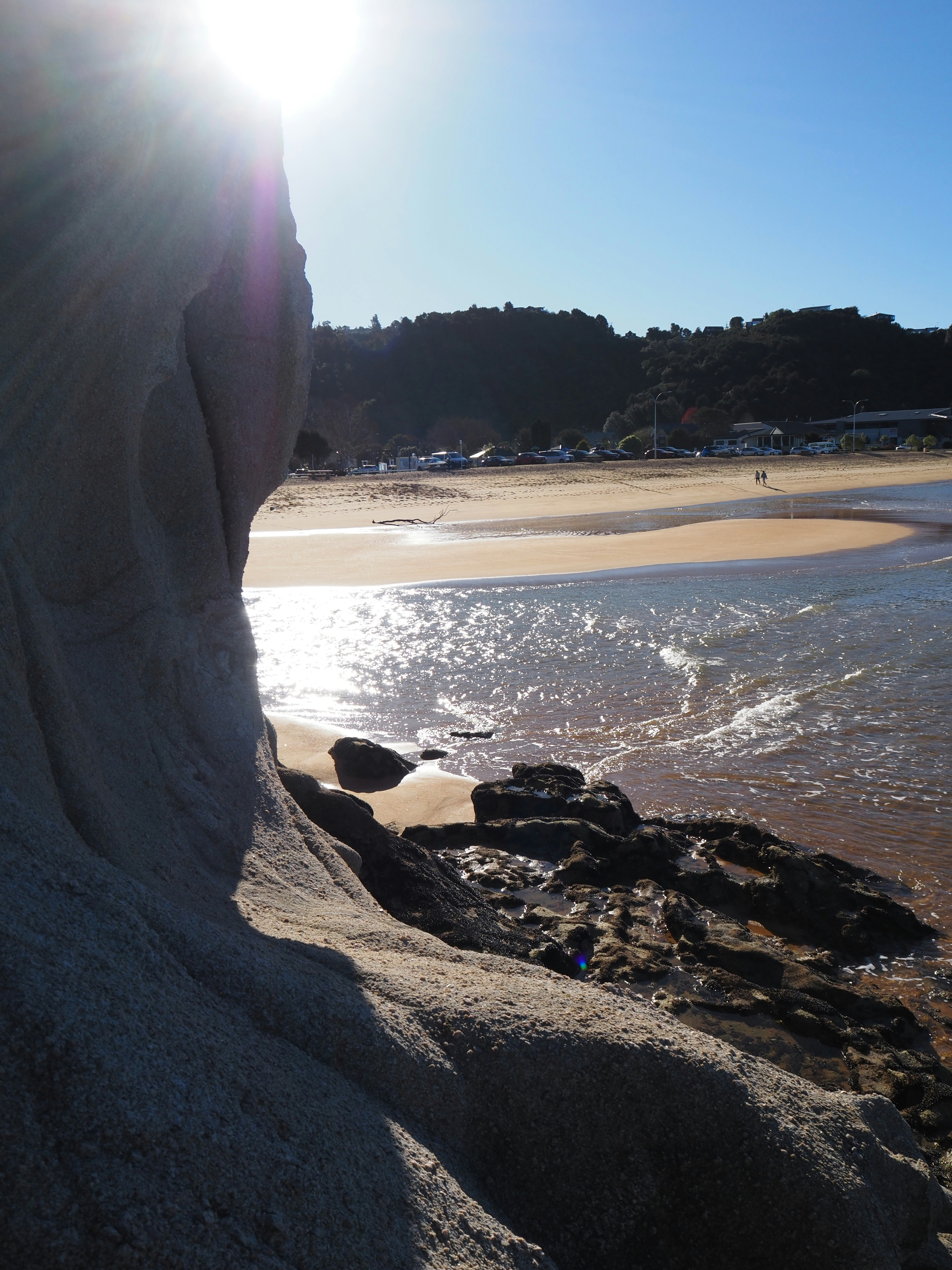 Sunlit Cliff Face Overlooking a Quiet Beach