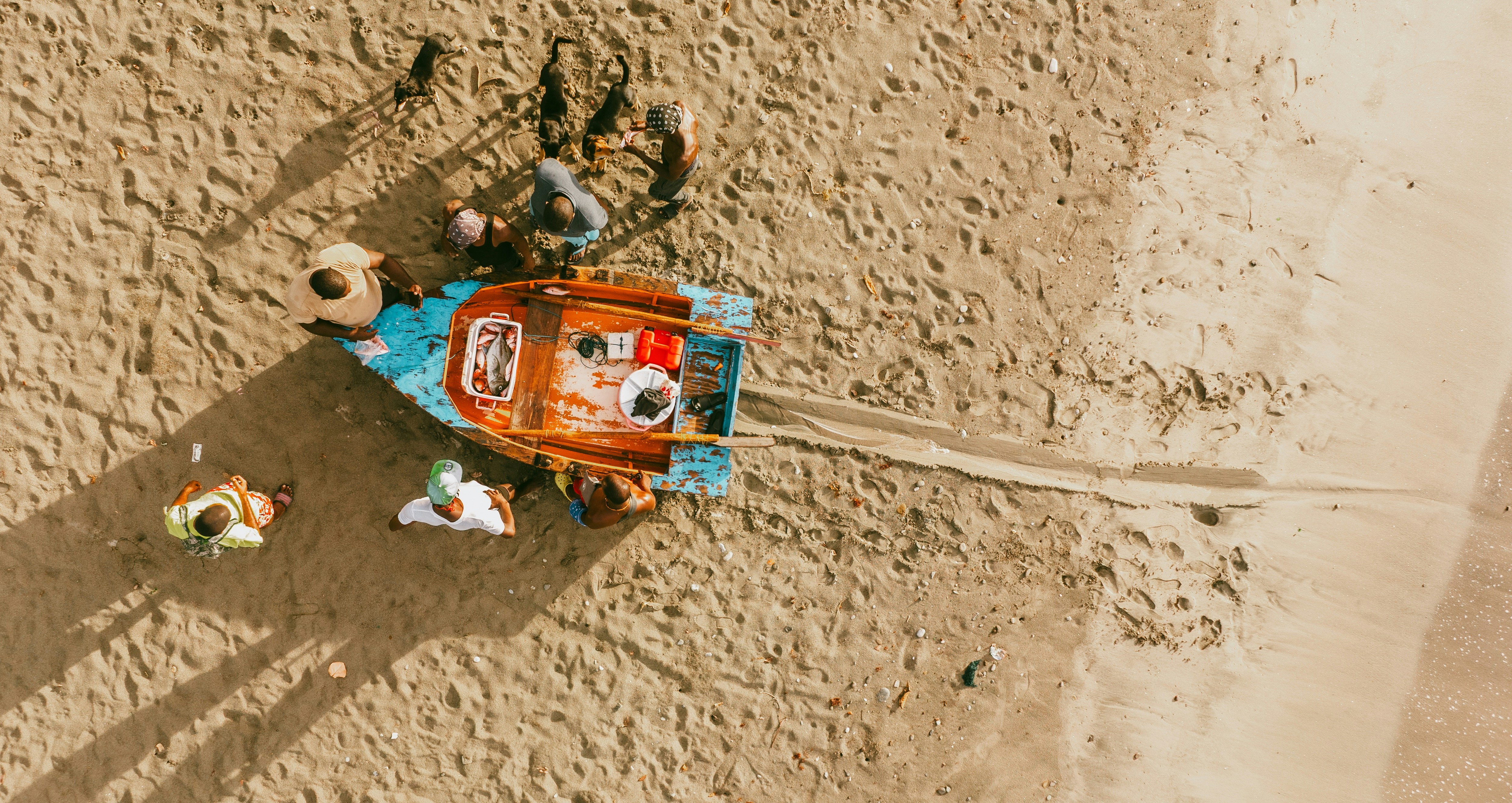Aerial Rescue on the Tideline: Crew and Boat in Coastal Sand