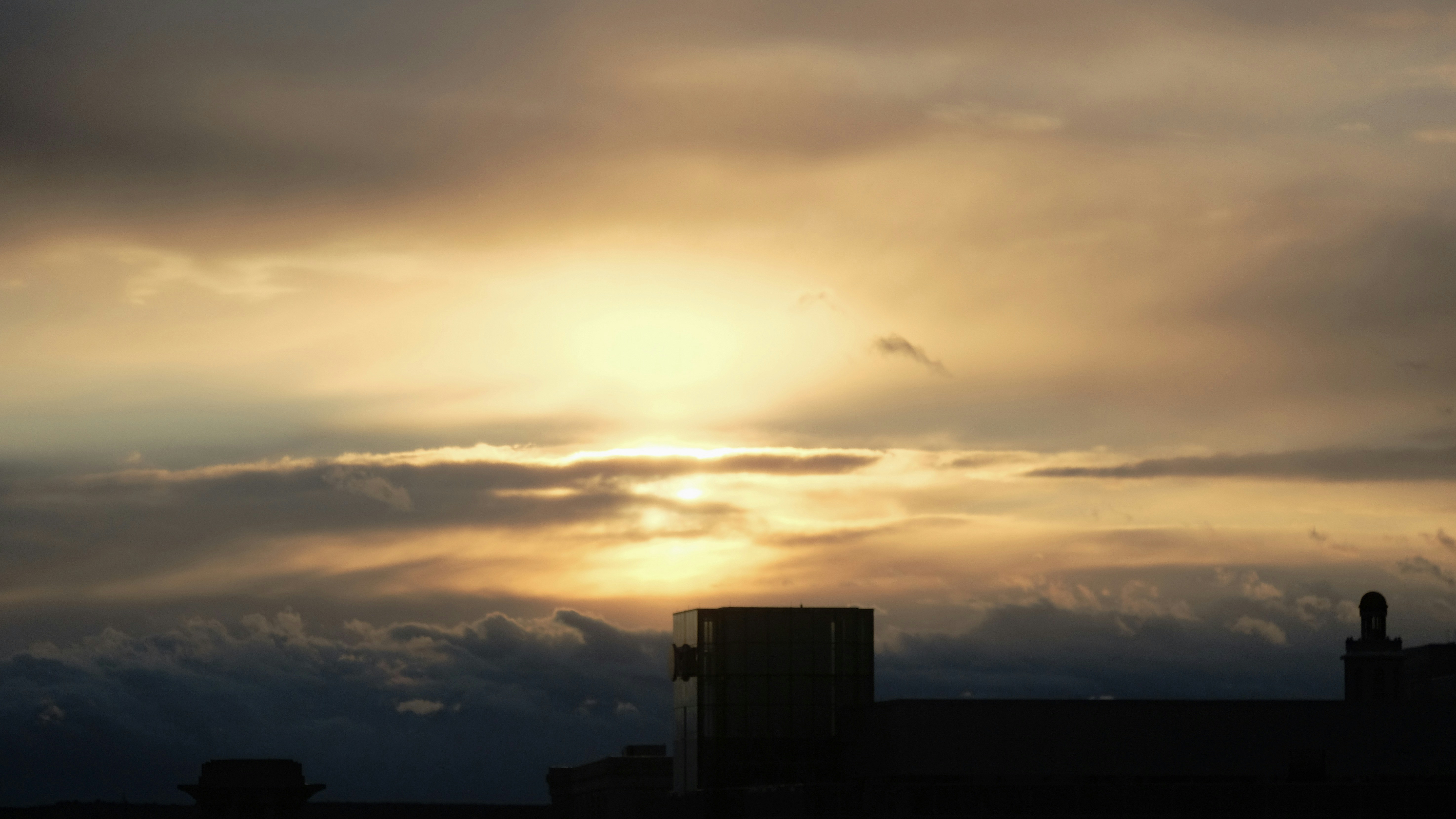 Sunset Over the Silhouettes: Rooftops Beneath a Glowing Horizon