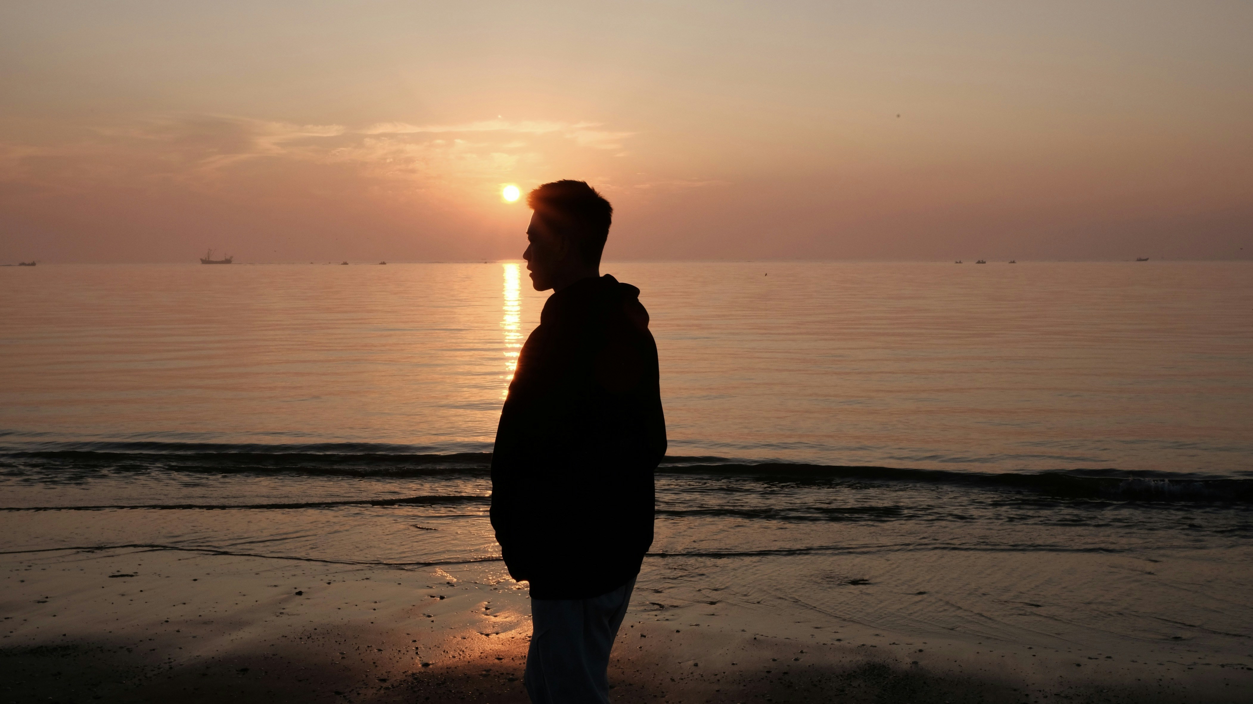 Silhouette at Sunset: A Quiet Shoreline Moment