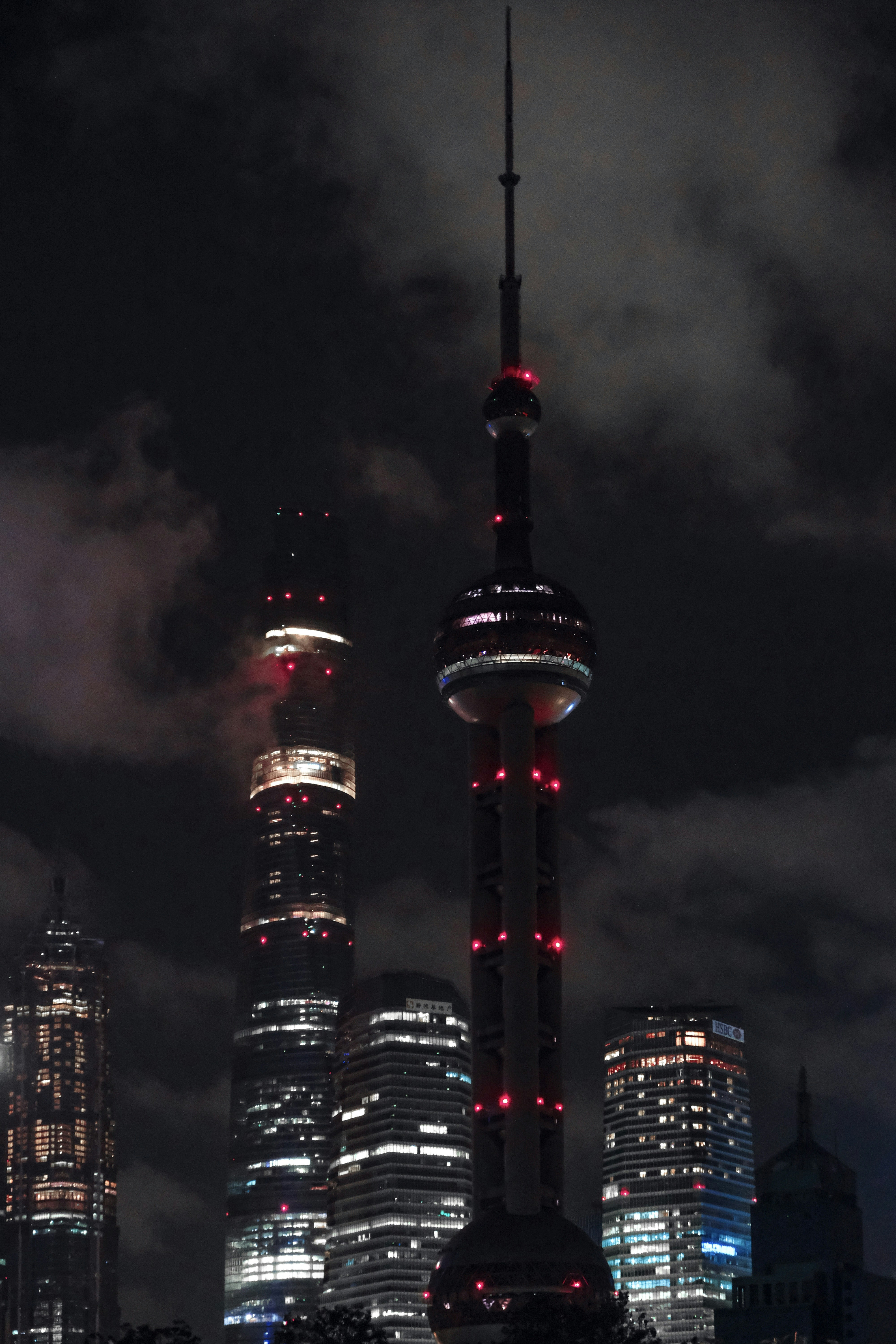 Midnight Needle: The illuminated TV Tower among the Clouded Skyline