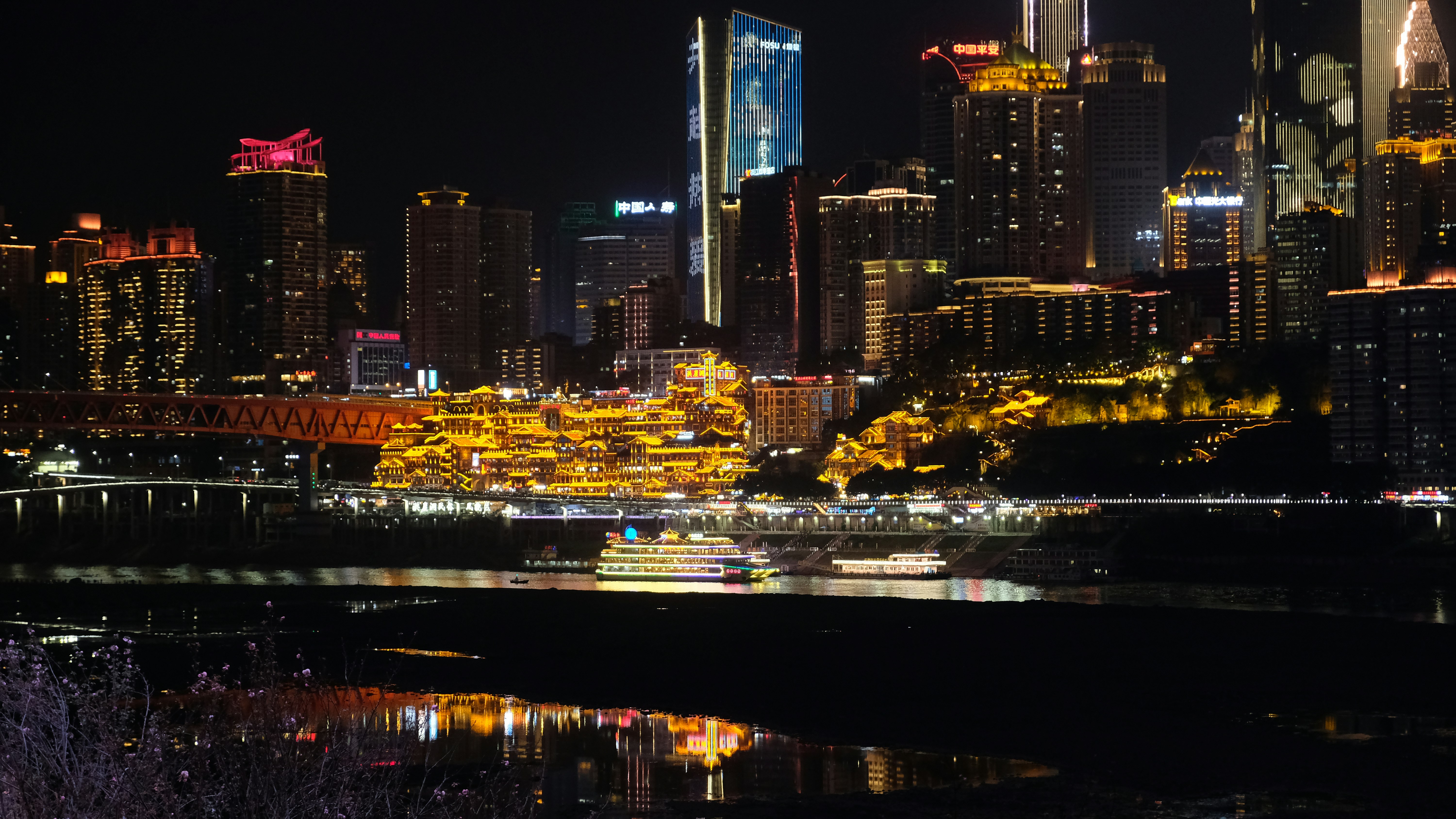 City Lights Afloat: Nighttime Skyline Reflections Over the River