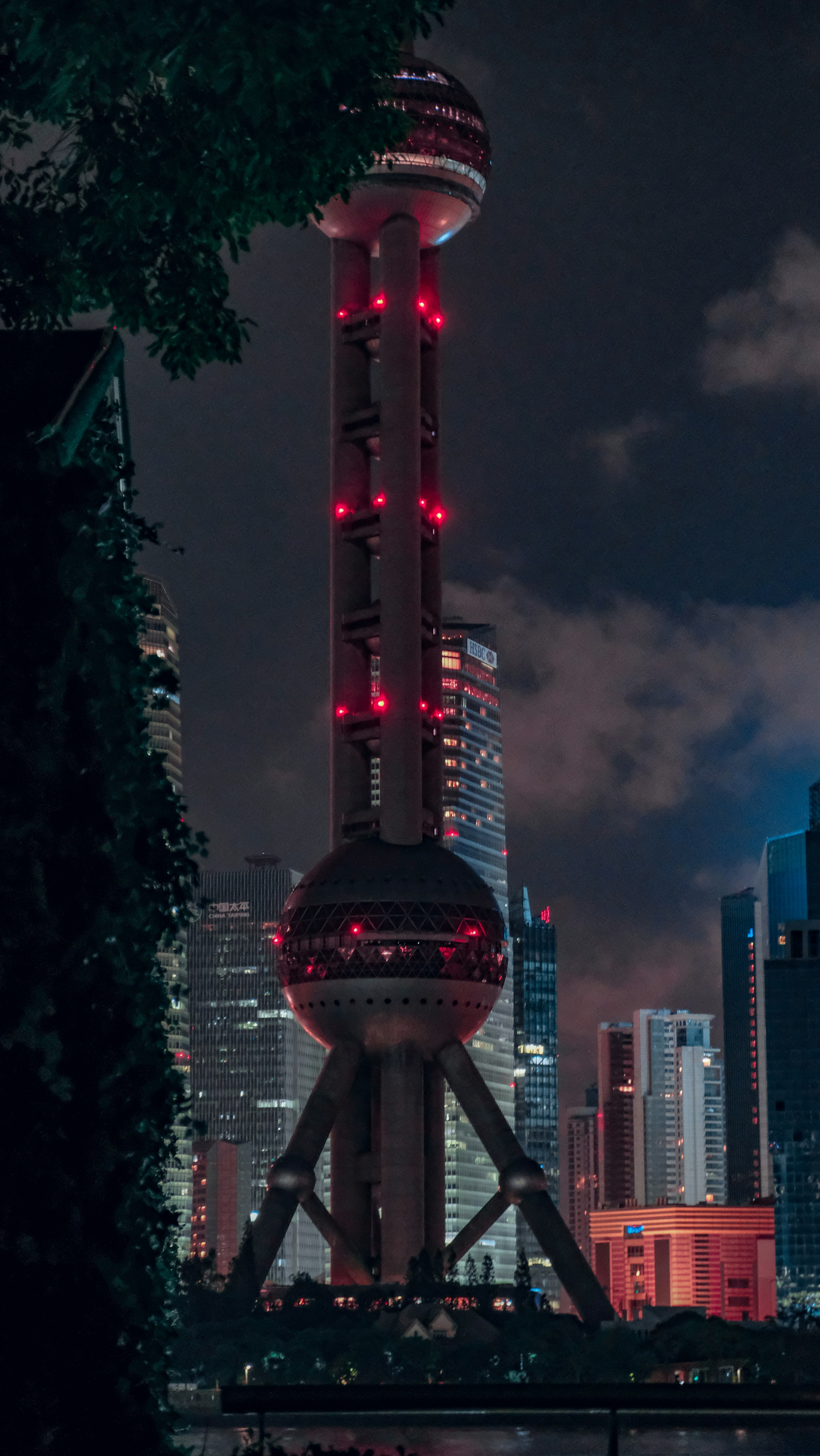 Neon Sentinel: The Shanghai Tower Glow Framed by Night