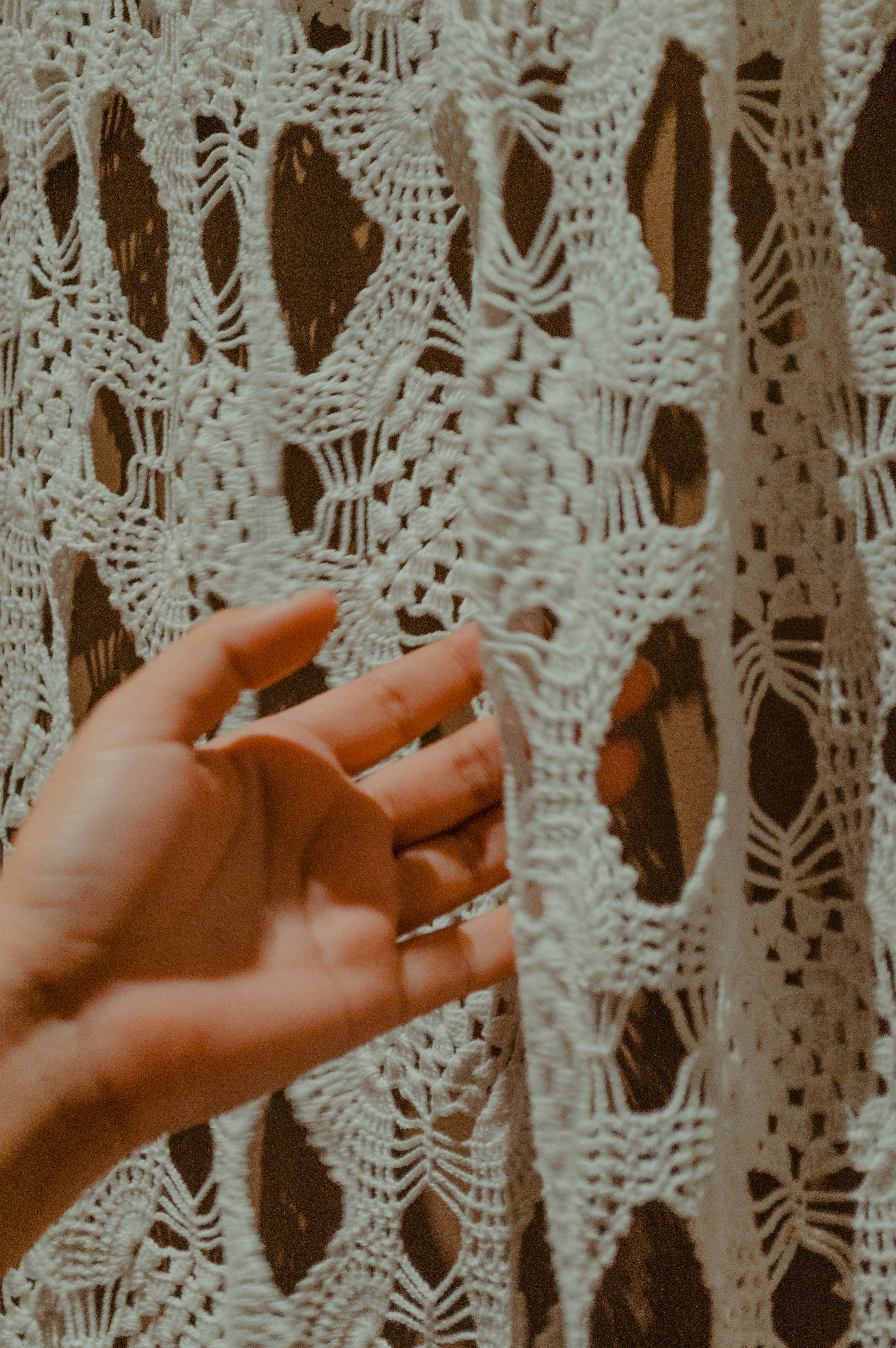 Hands in Lace: A Gentle Touch Through White Crochet Veil