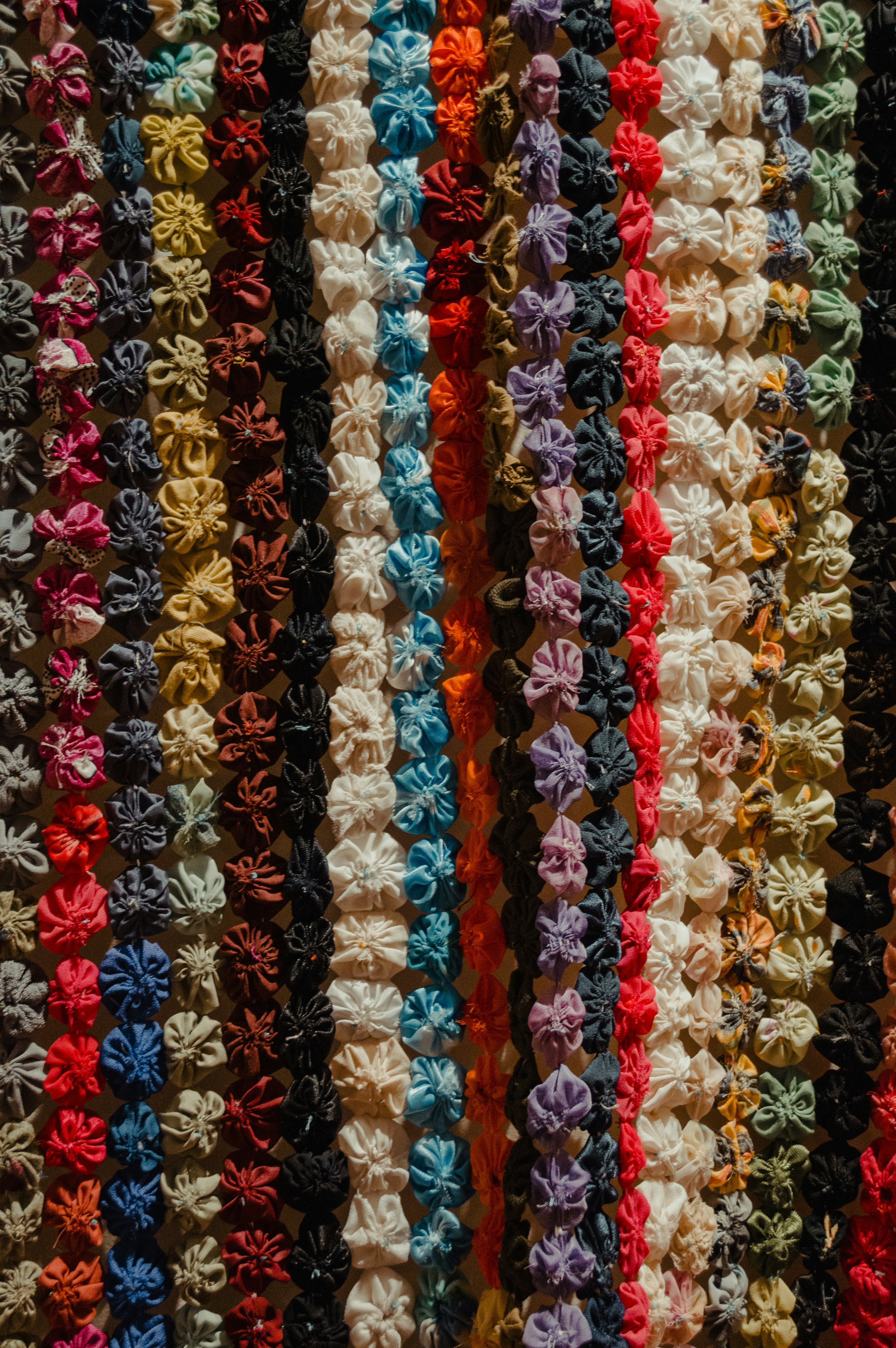 Ribboned Kaleidoscope: A Vertical Garden of Fabric Flowers