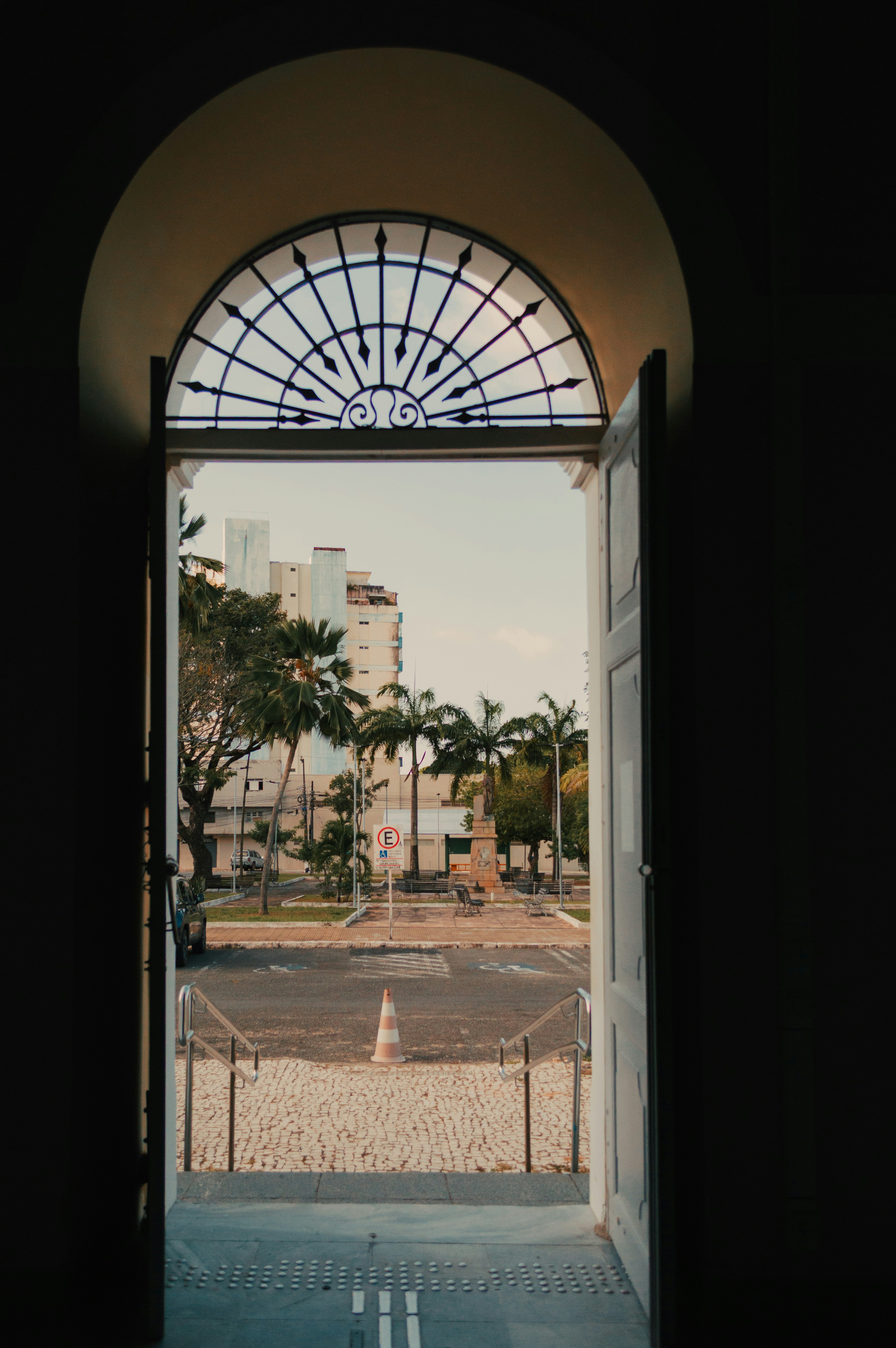 Doorway to the City: Palm Trees and Street Scene Framed by Arch