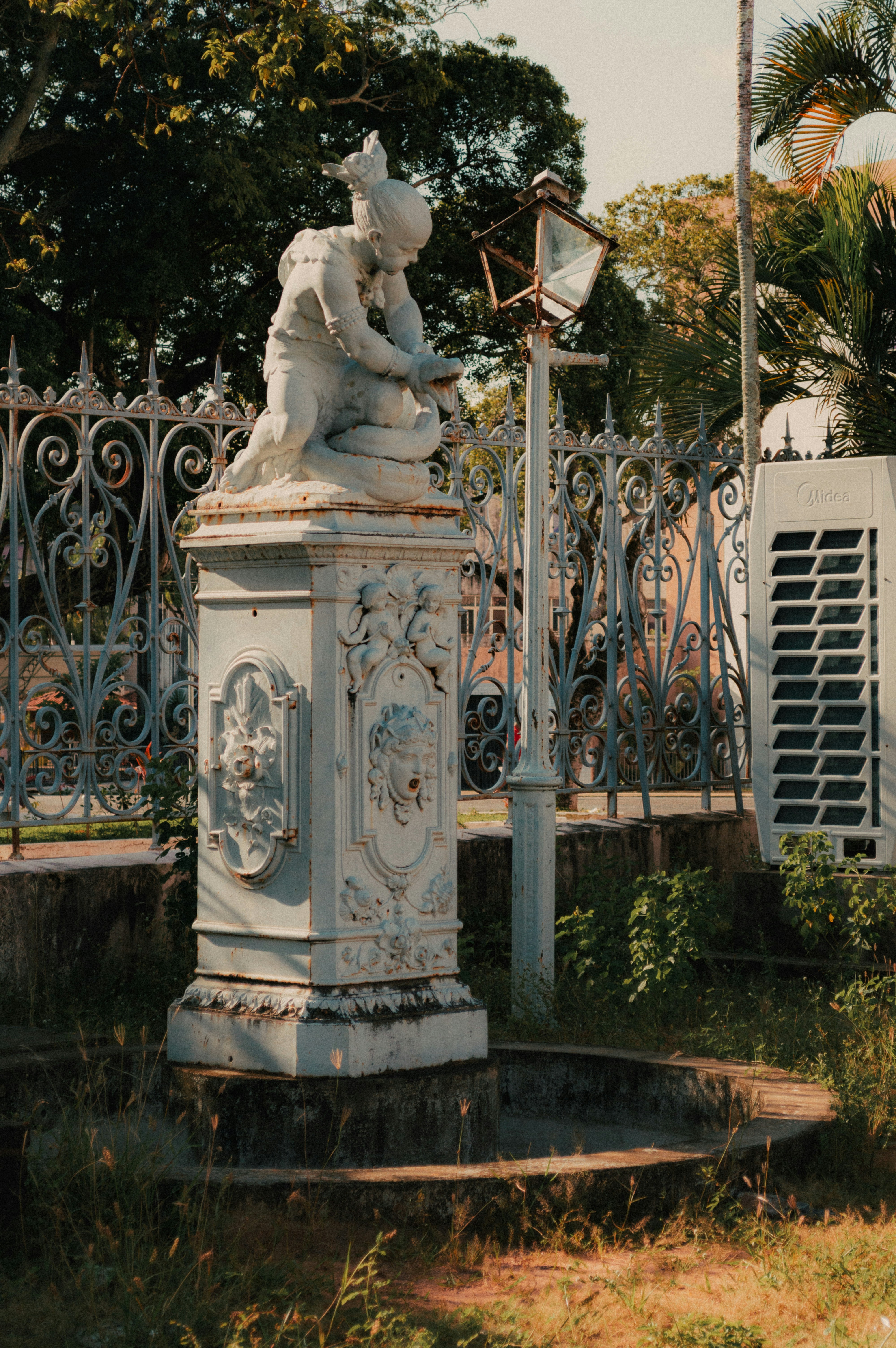 Stone Cherub Statue Guarding the Gate