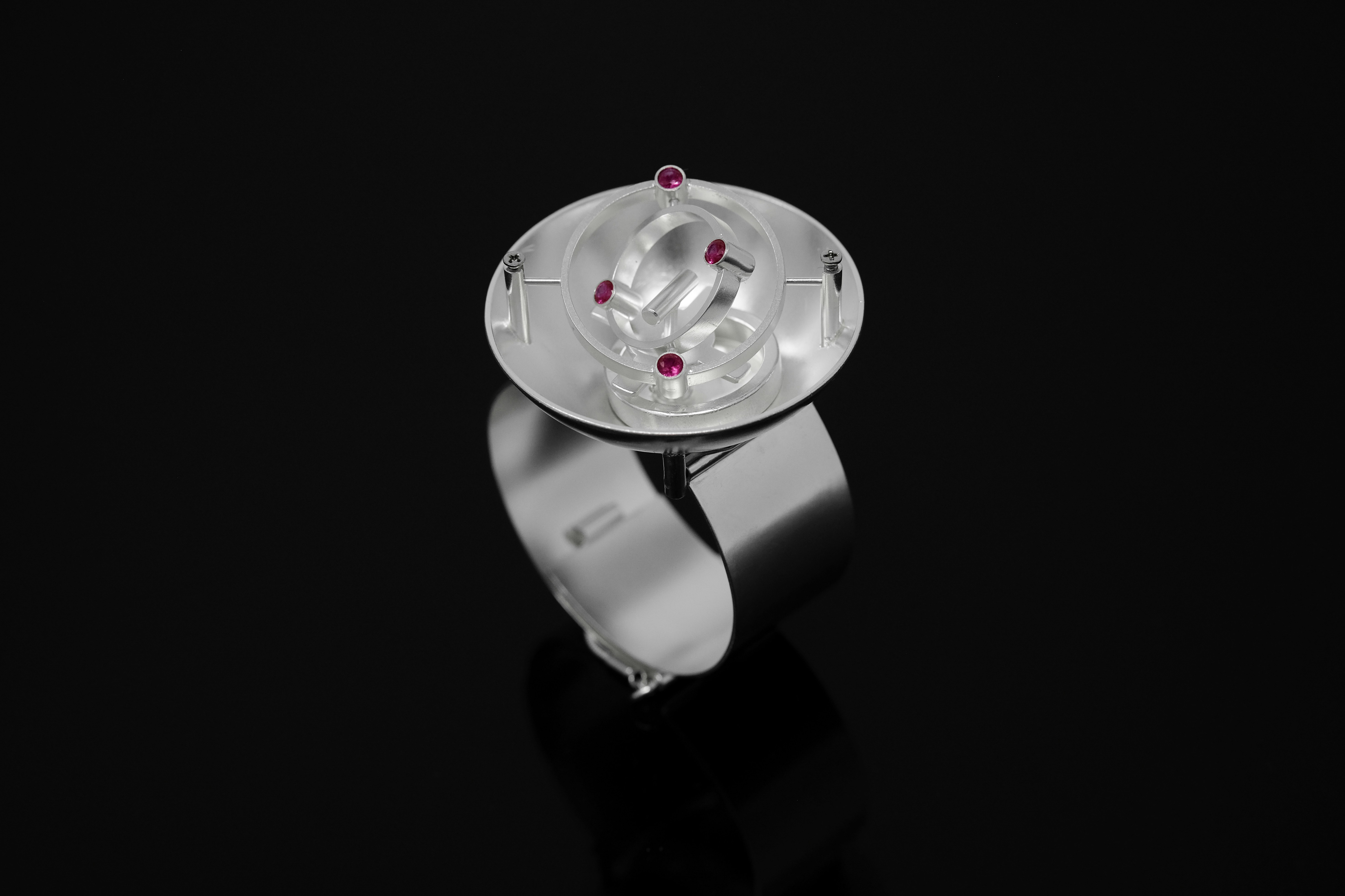 Minimalist Prism: A Metallic Ring with Pink Accents in Velvet Darkness