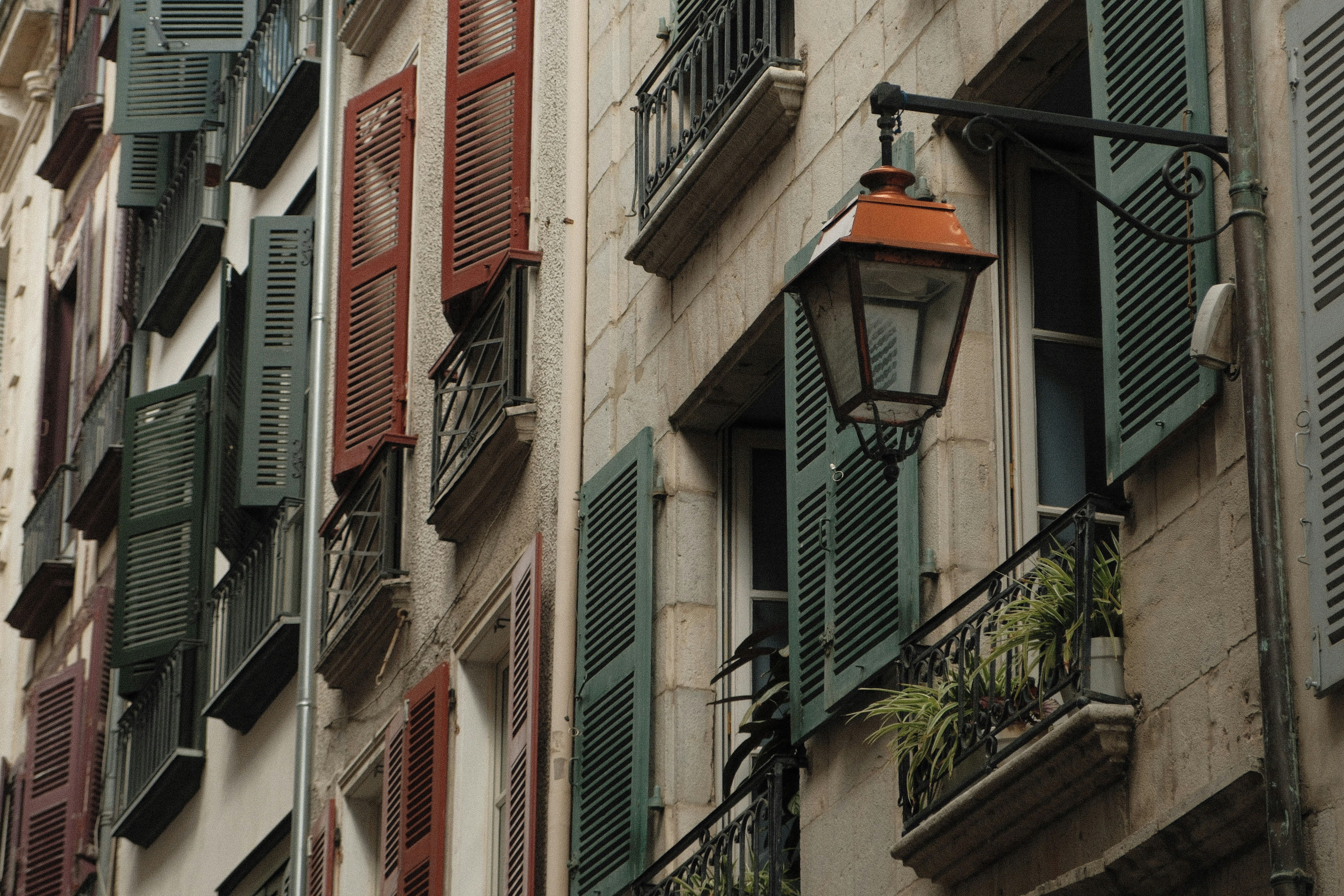 Colorful Shutters and a Lantern: A Street Face in Warm Light