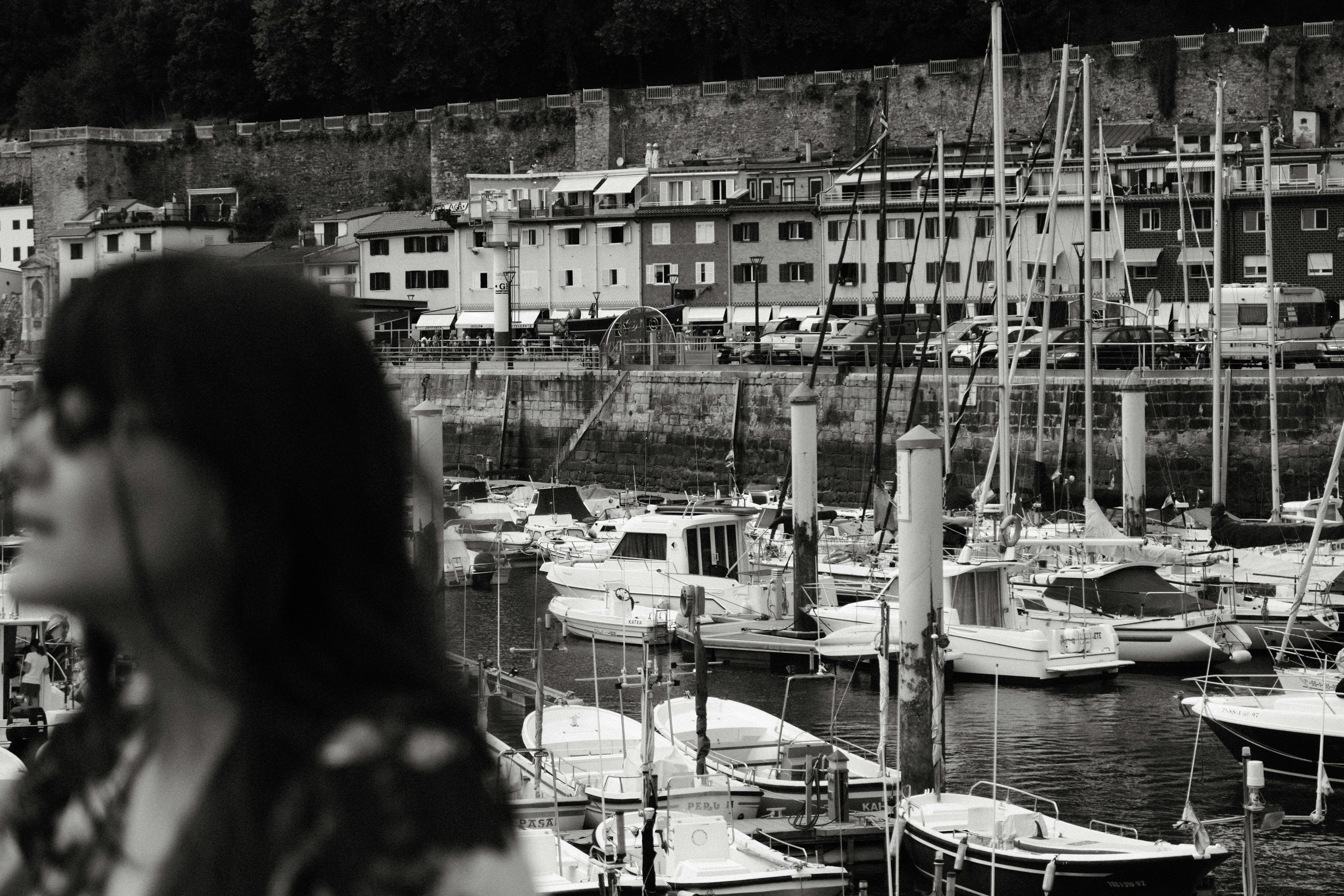 Blurry Foreground Figure Overlooking a Marina Grid
