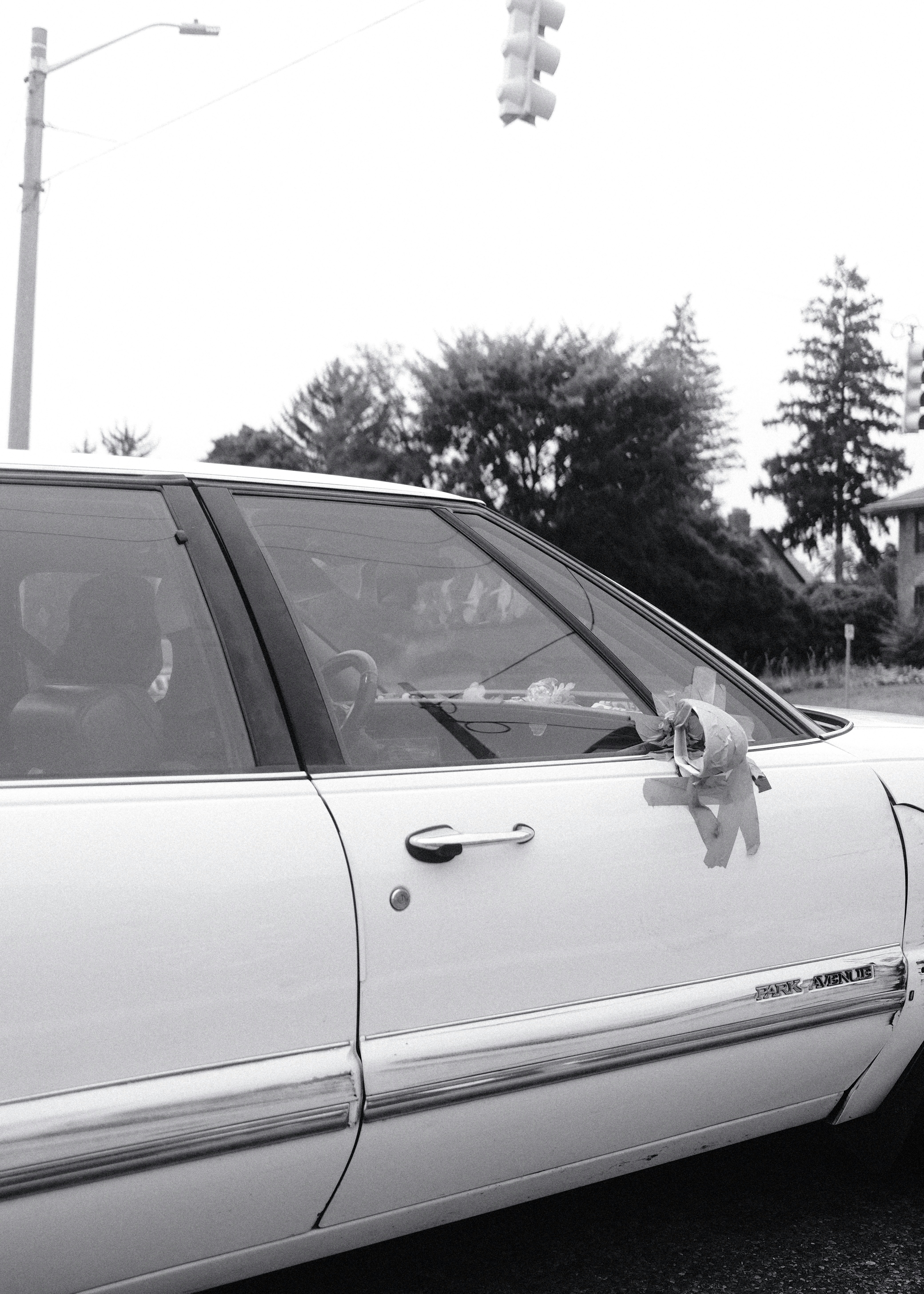 Ribboned Car at Rest: A Quiet Moment by the Street