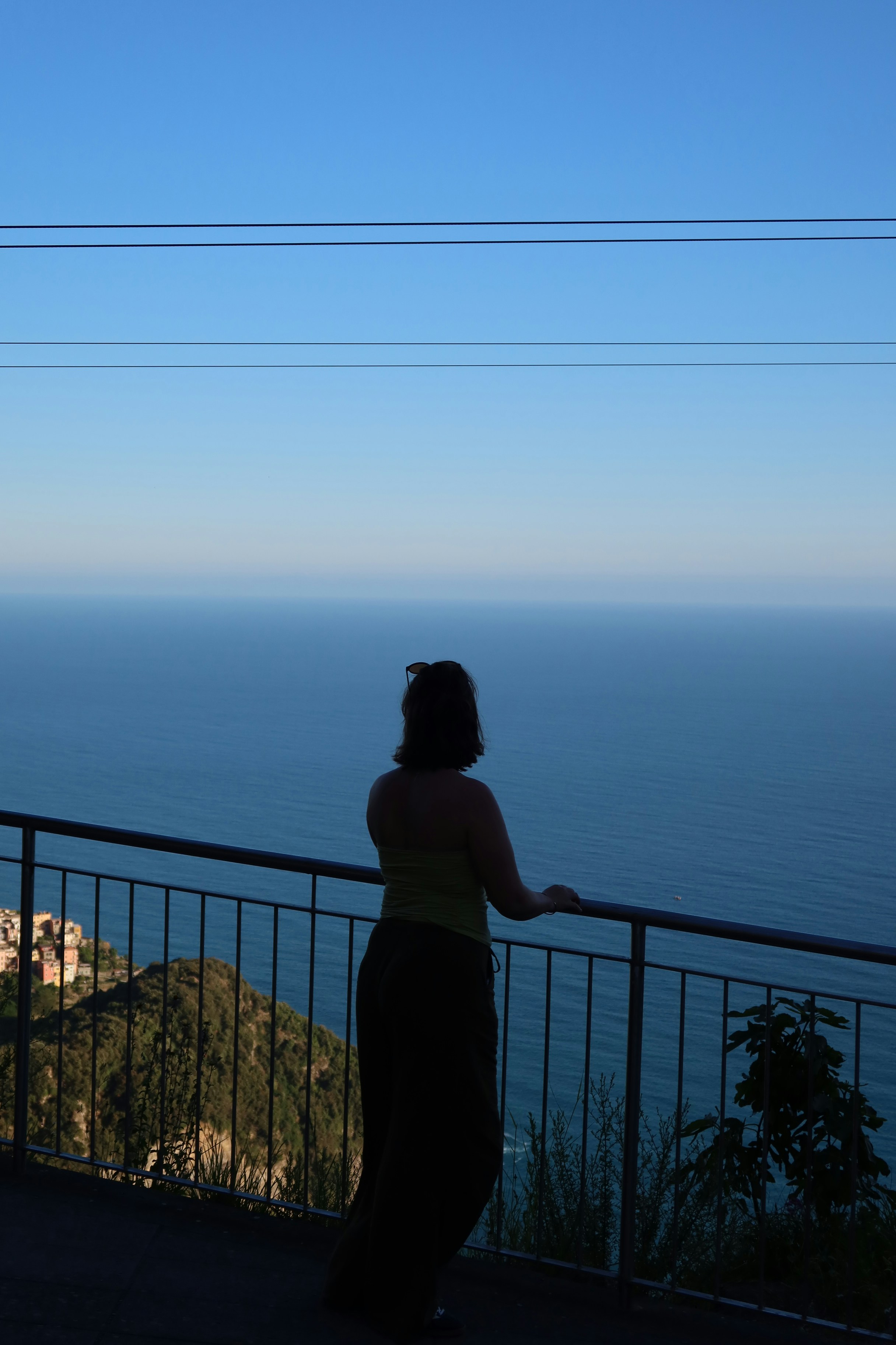 Overlooked Horizon: A Silhouetted Traveler Gazes Toward the Sea