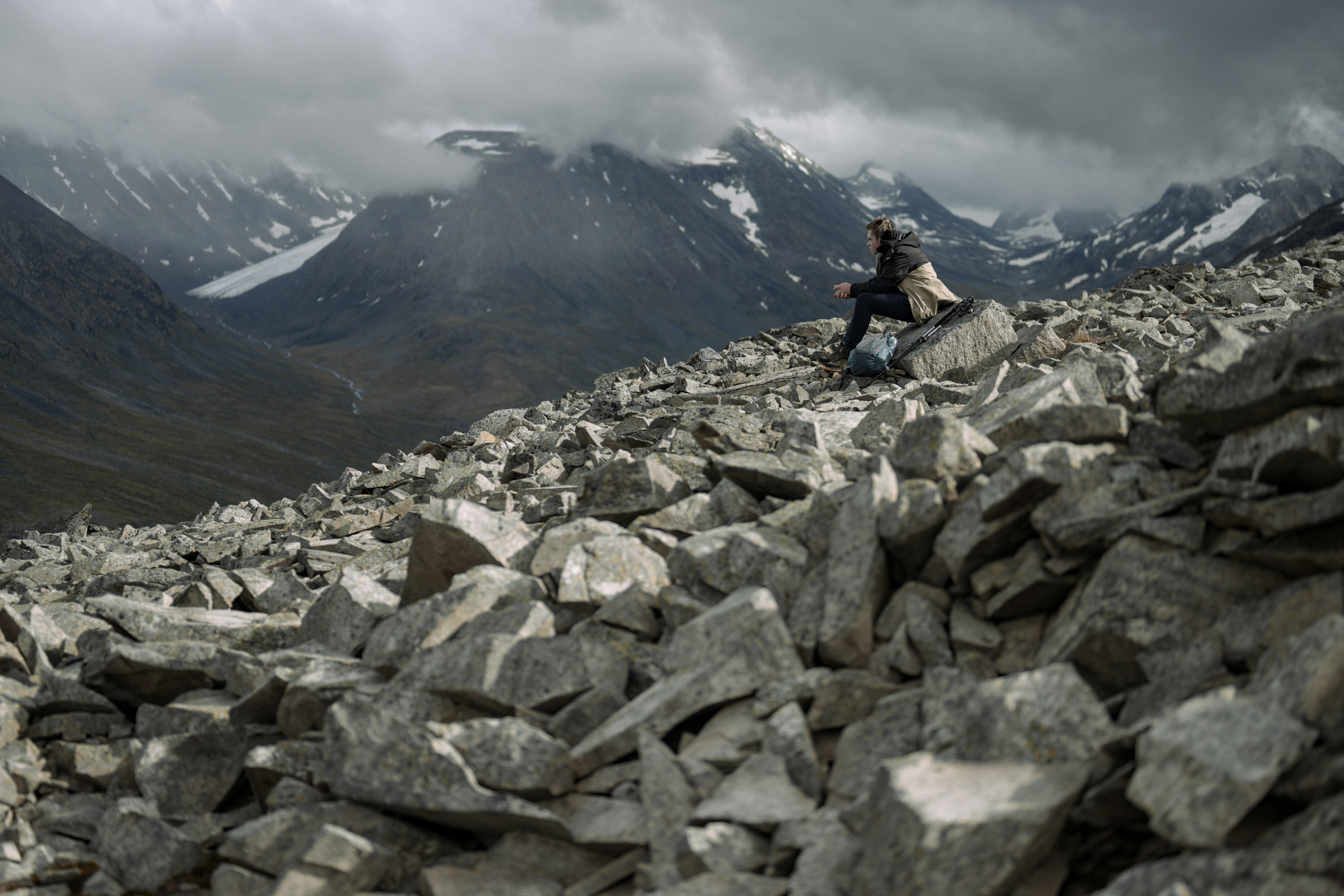 Ridge Wanderer: Solitary Figure Amidst Alpine Scree
