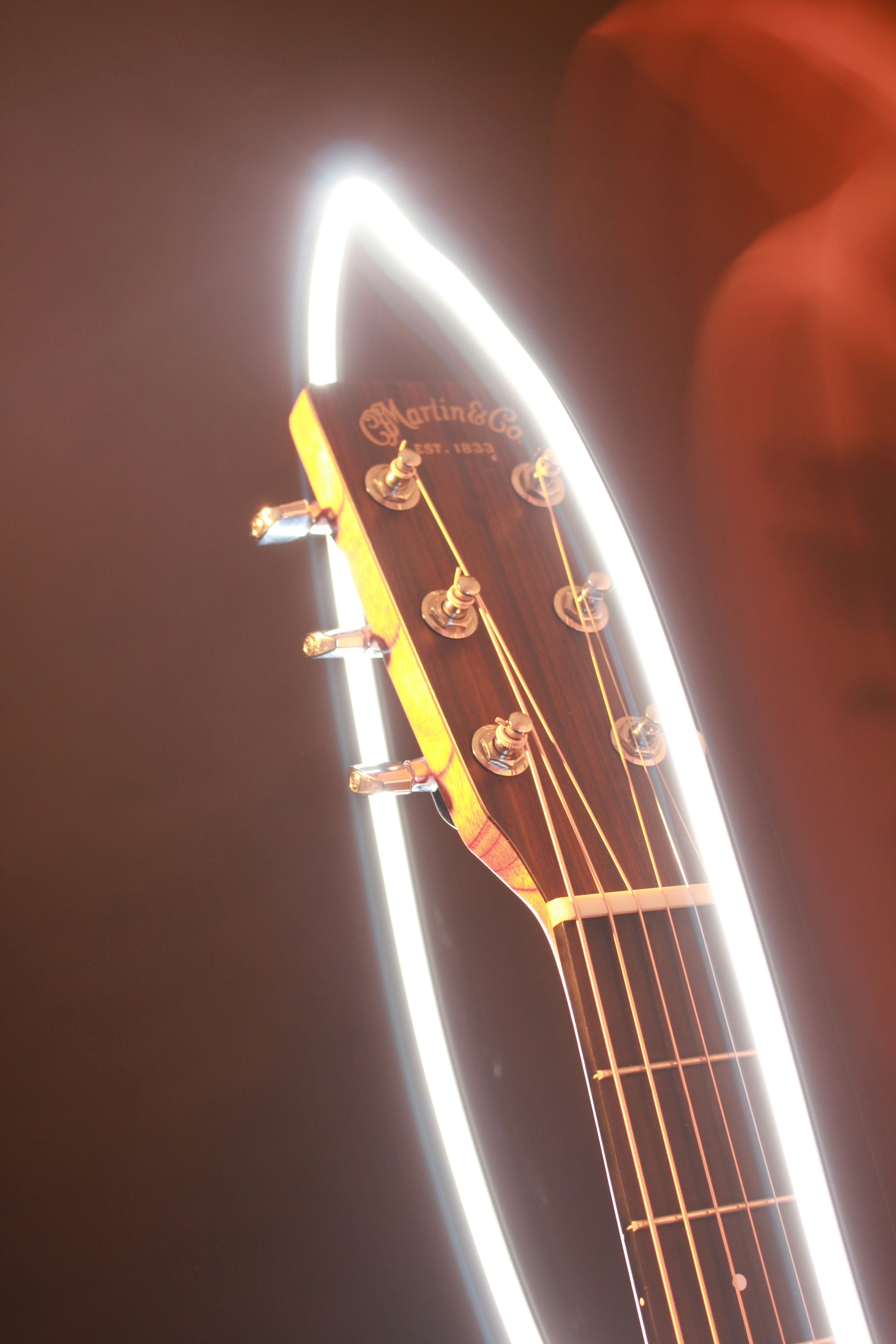 Neon-Outlined Guitar Headstock in Velvet Night