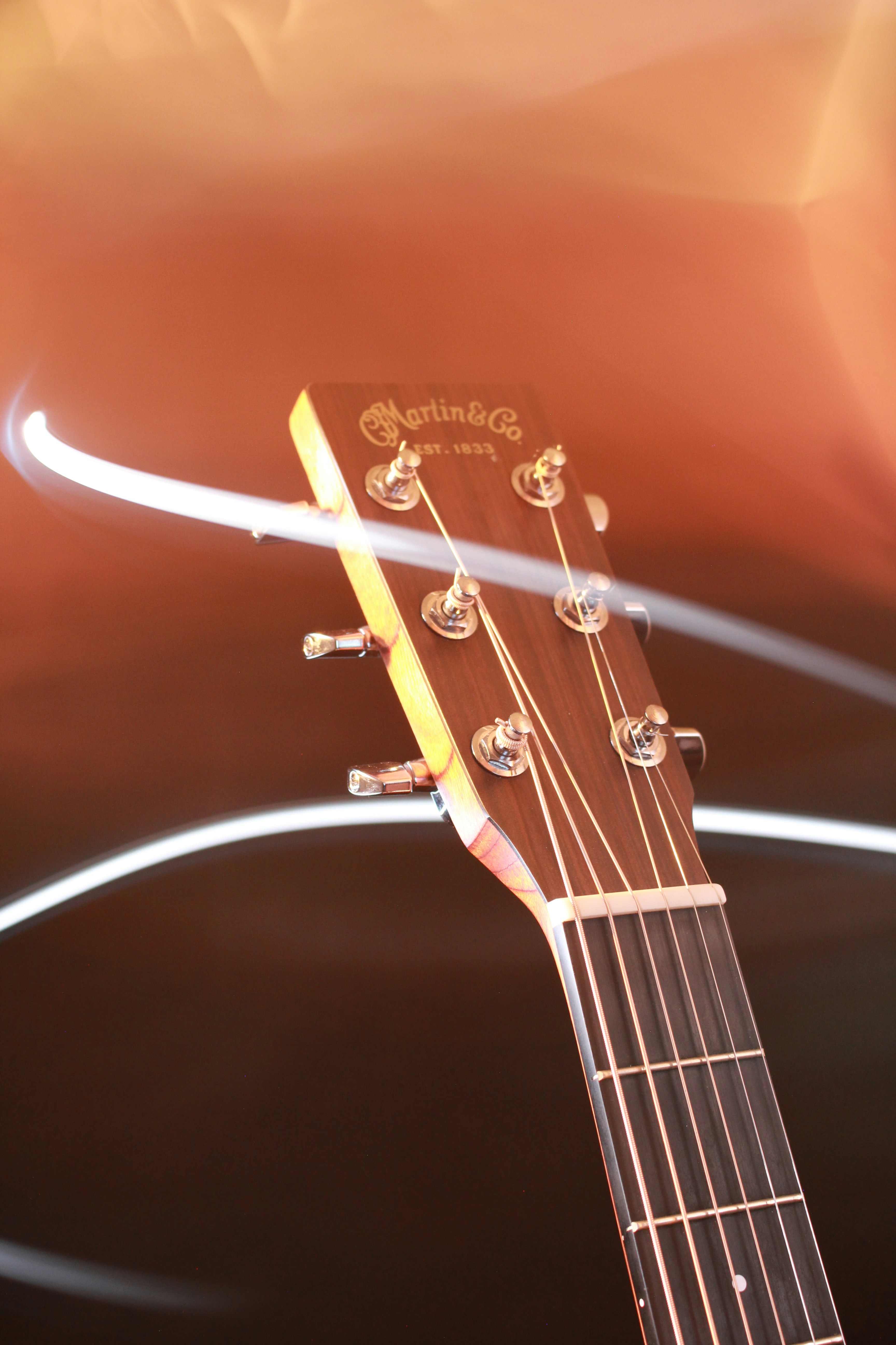 Guitar Headstock in Warm Light: A Portrait of Craft and Motion