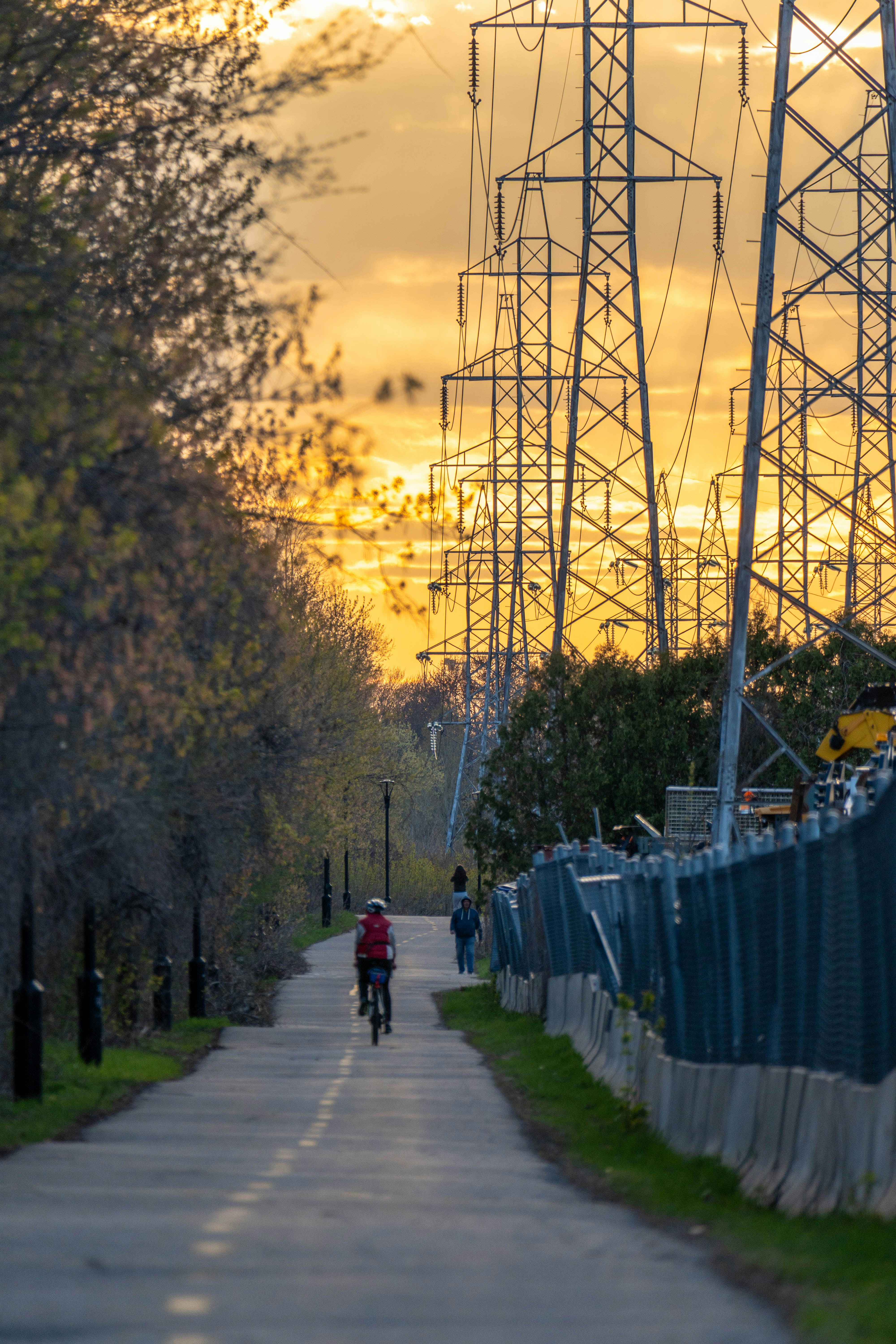 Sunset Route: Biker and Pedestrian Through a Powerline Corridor