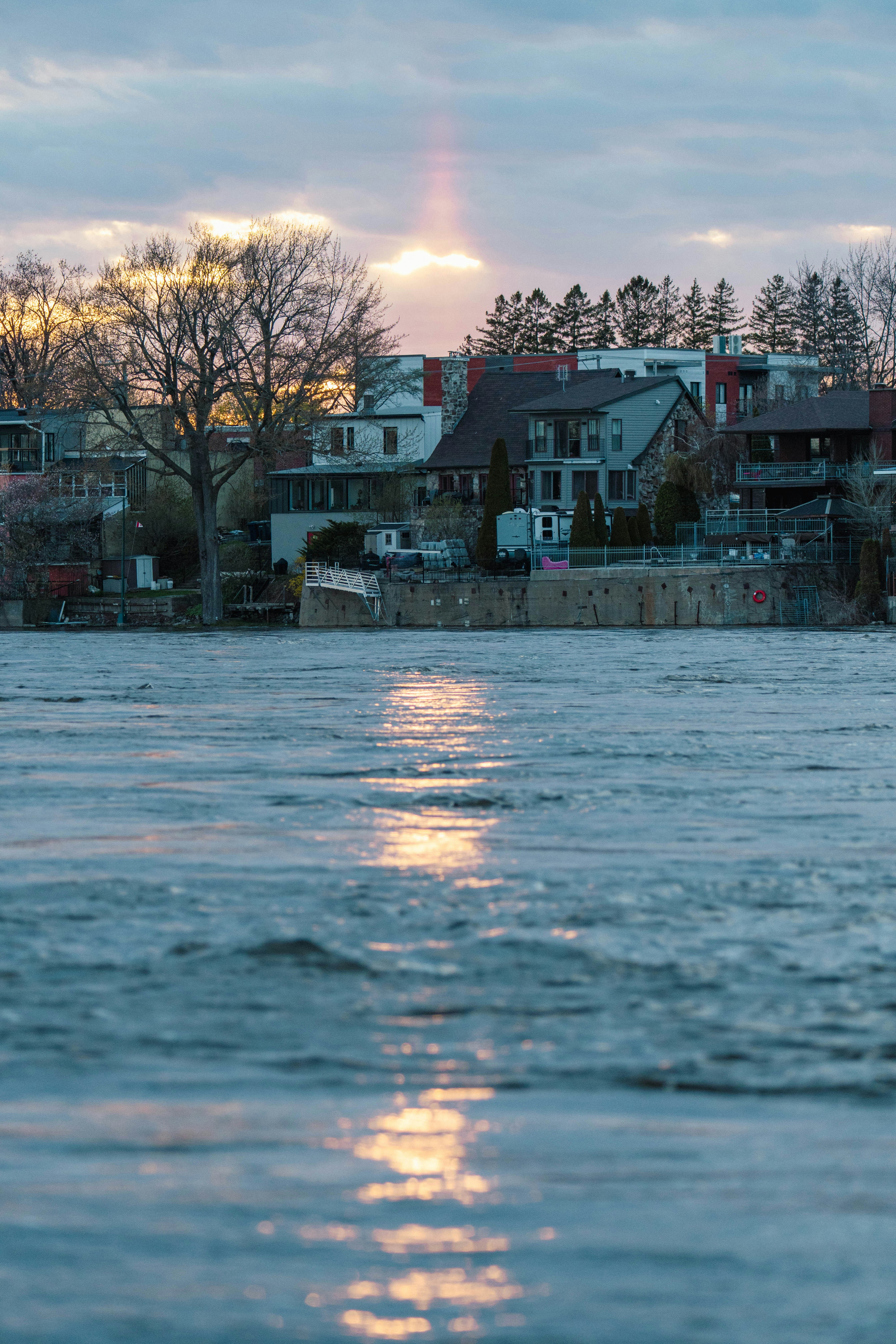 Dusk on the Riverfront: Sunset Light Weaving Through Quiet Homes