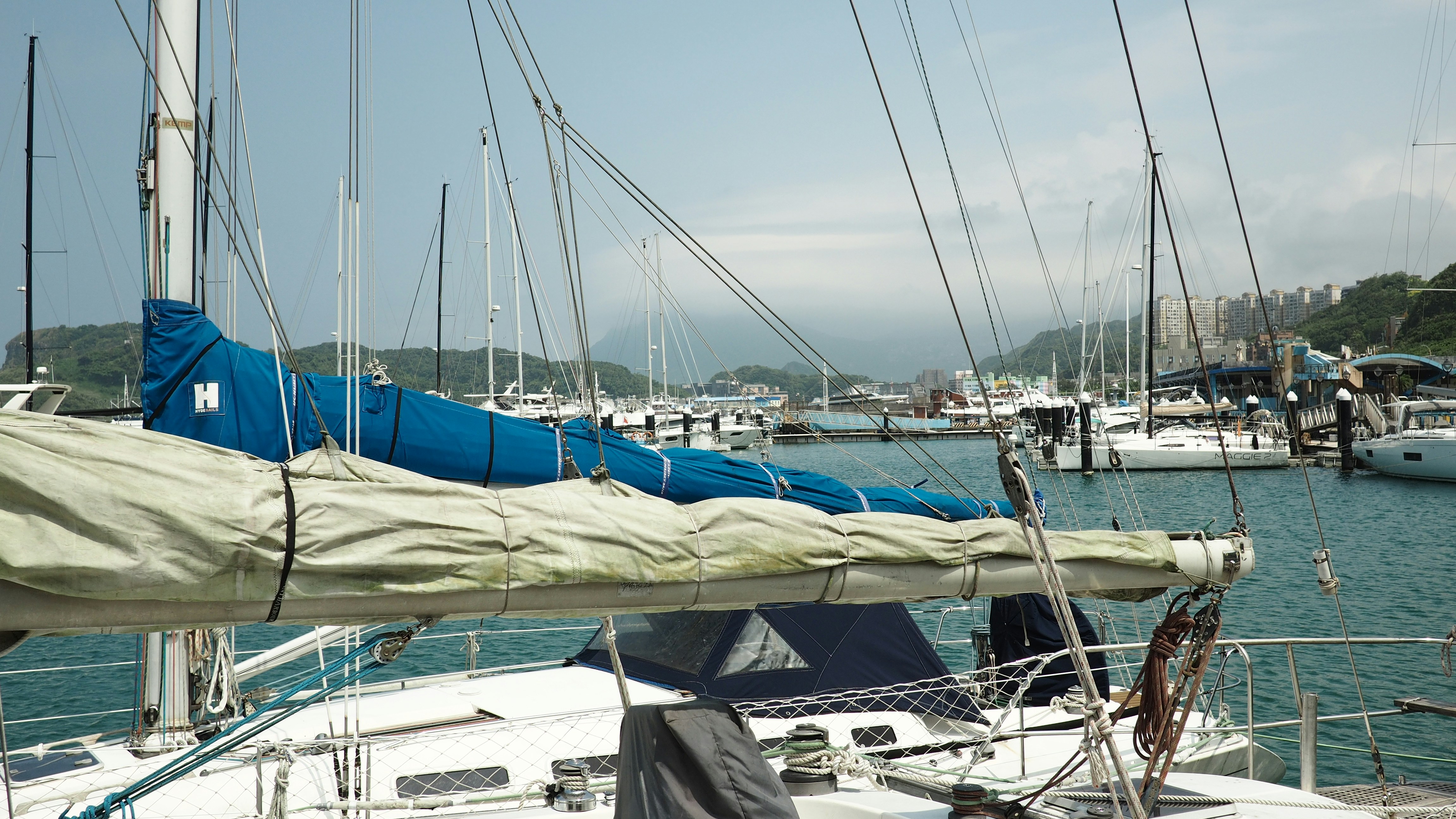 Masts and canvas in a sunlit marina