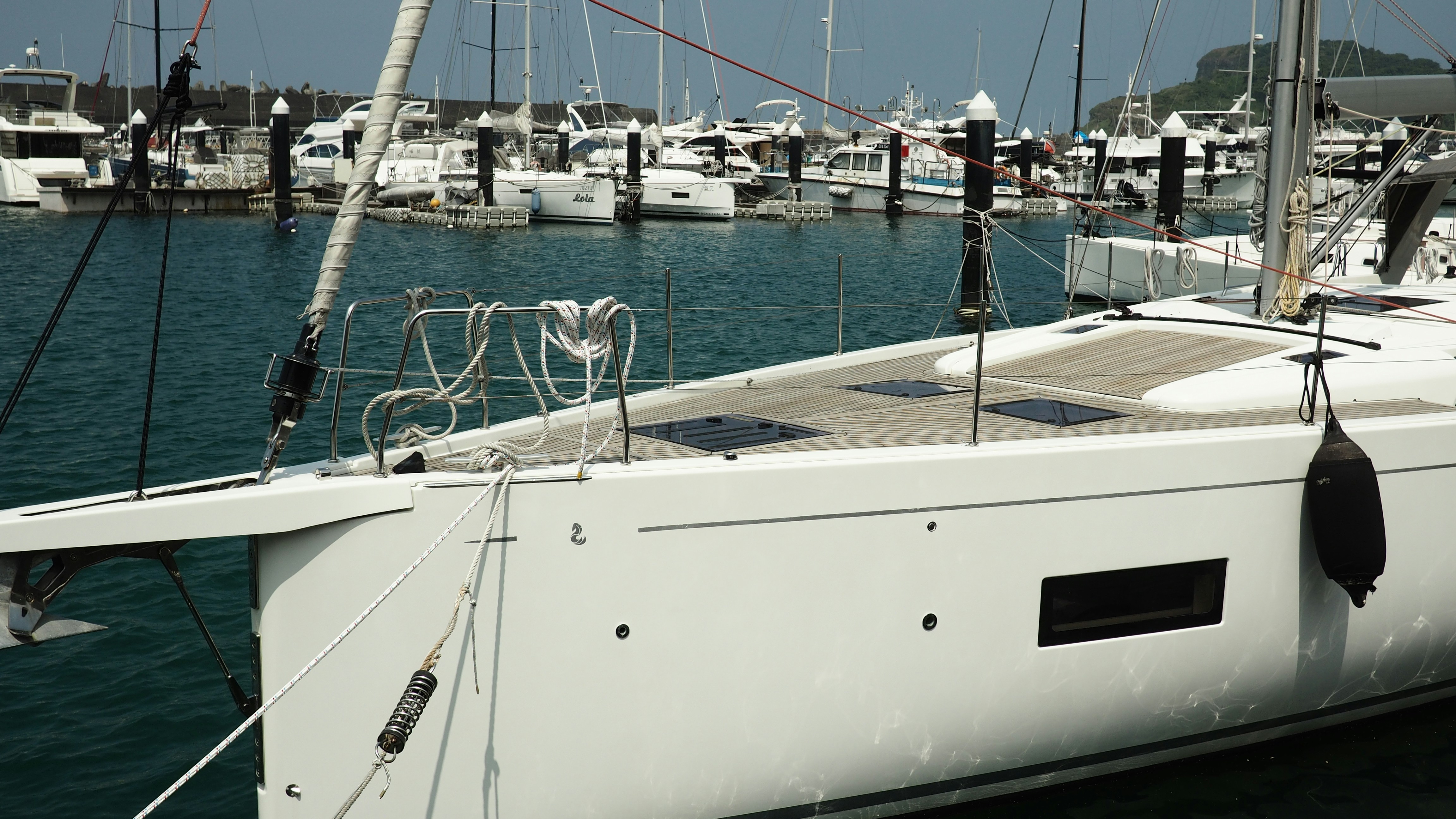 White Sloop at Rest in a Quiet Marina