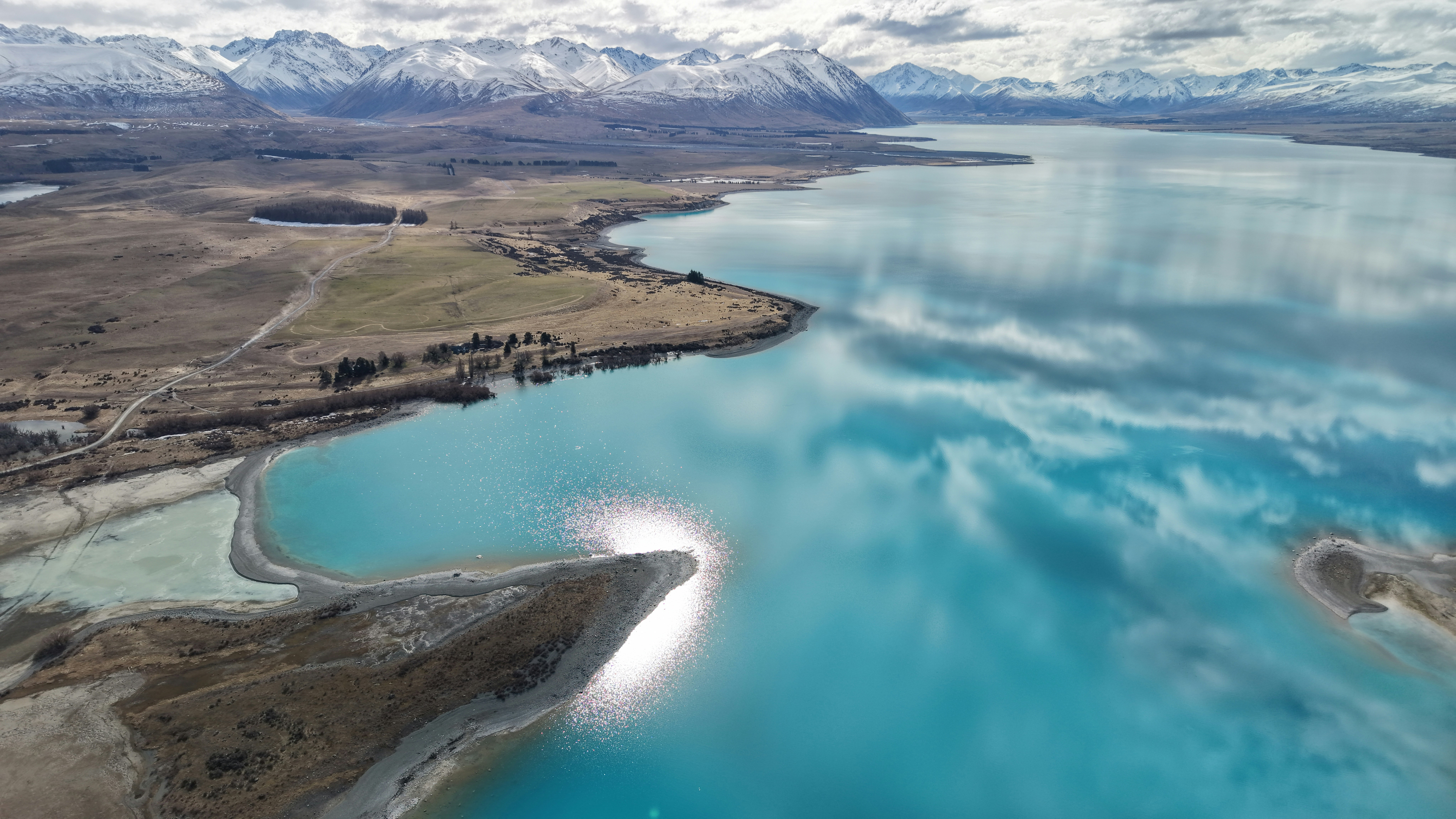Azure Inlet: Snow-Trimmed Mountains Guarding a Glacier-Blue Lake
