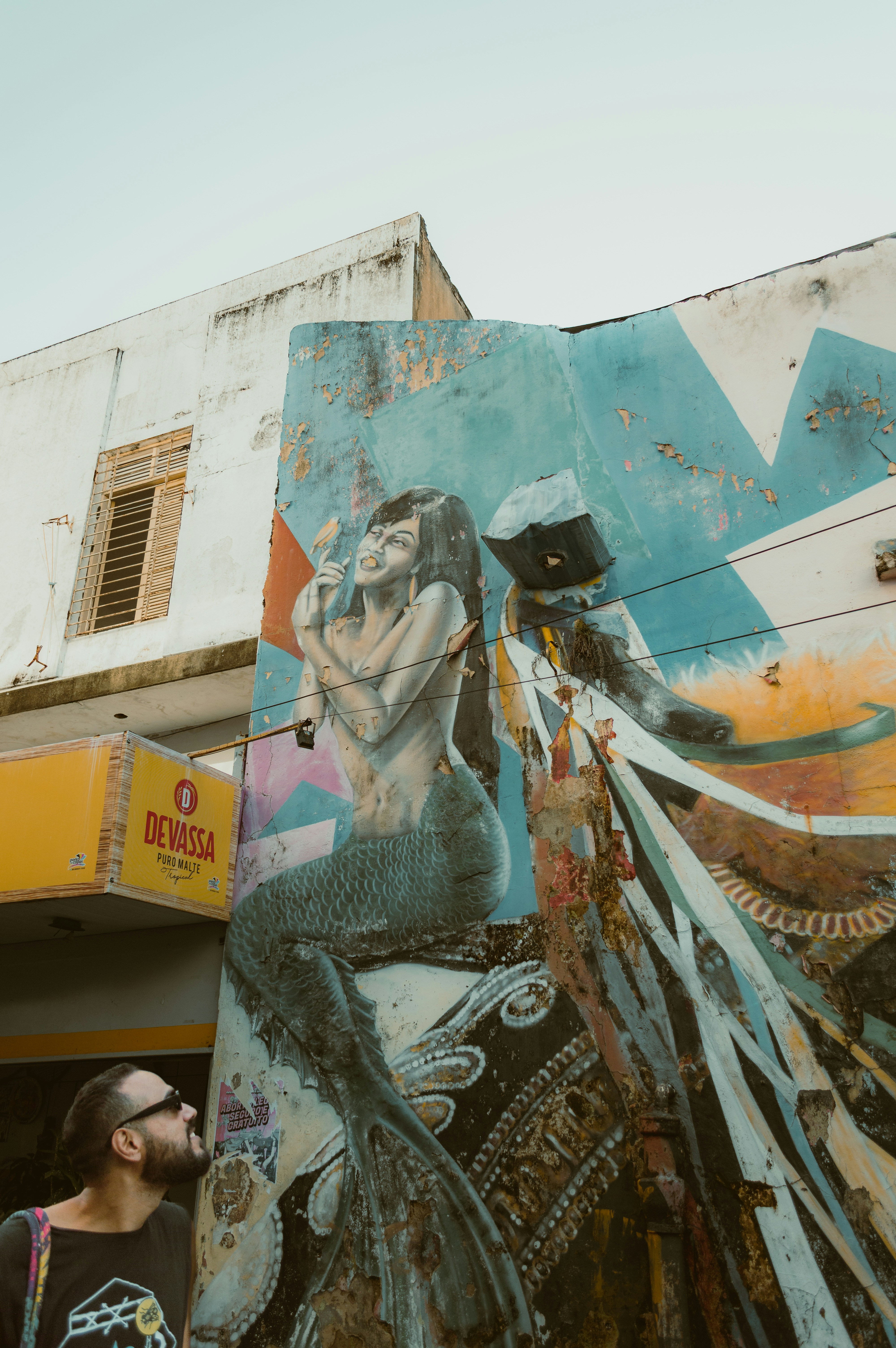 Mermaid Mosaic: Street Art Meets Sunlit Wall