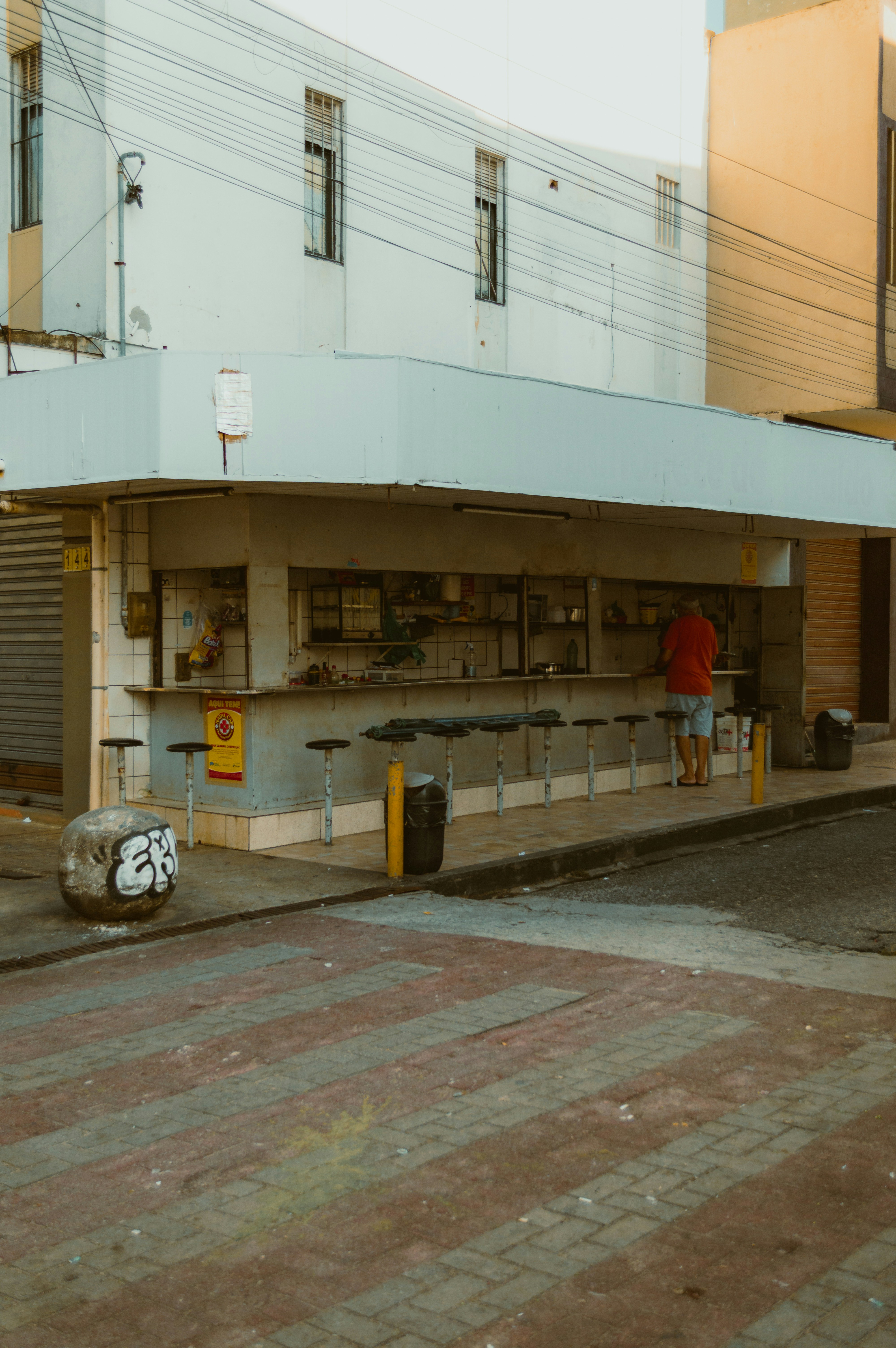 Warm Streetfront Café Bar with a Red-Sweatered Patron