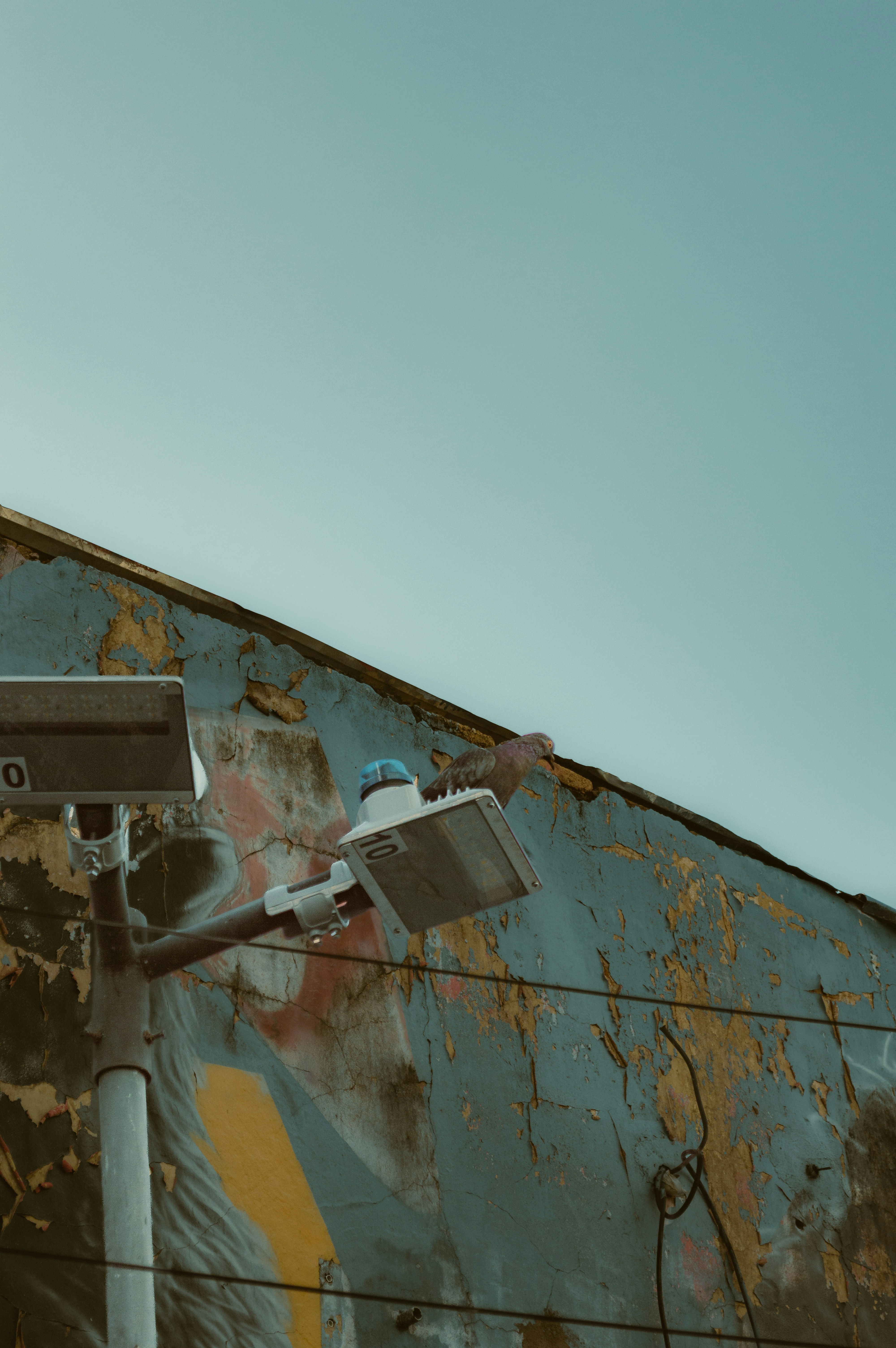 Atmosphere in Decay: Street Lamp against Weathered Wall
