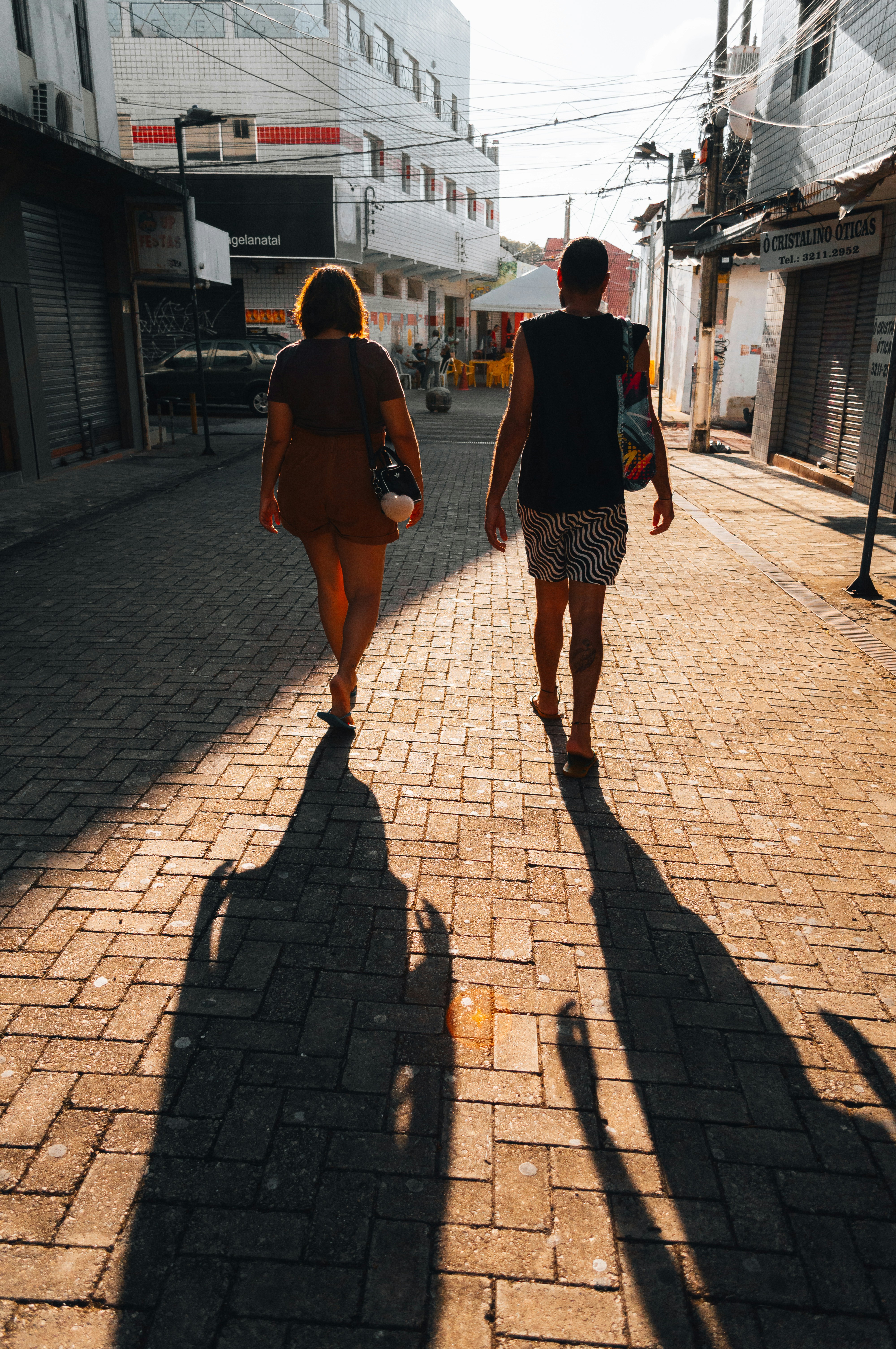 Sunlit Street Walk: Shadows and Stride