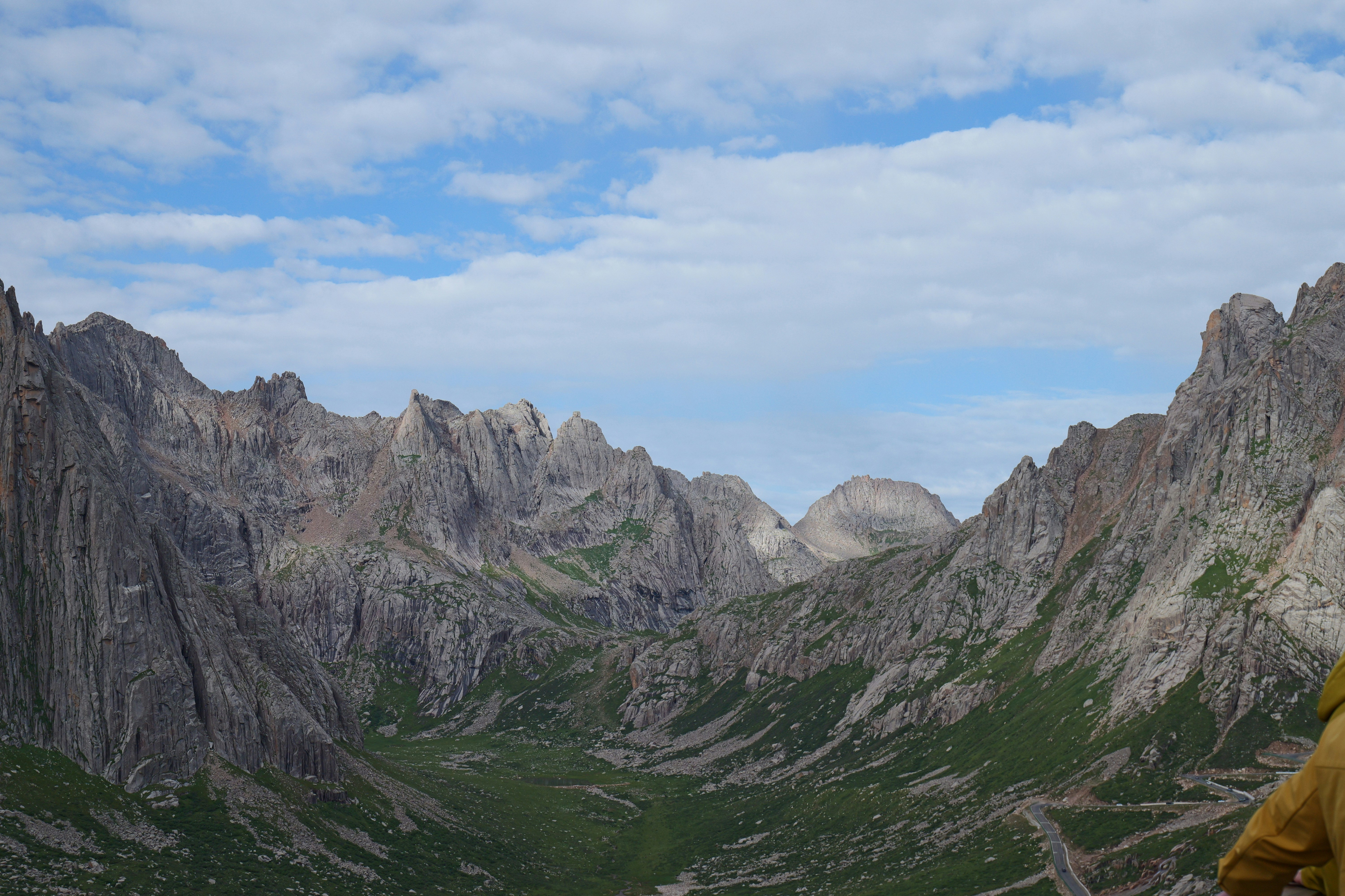 Valley of jagged peaks beneath a bright canyon sky