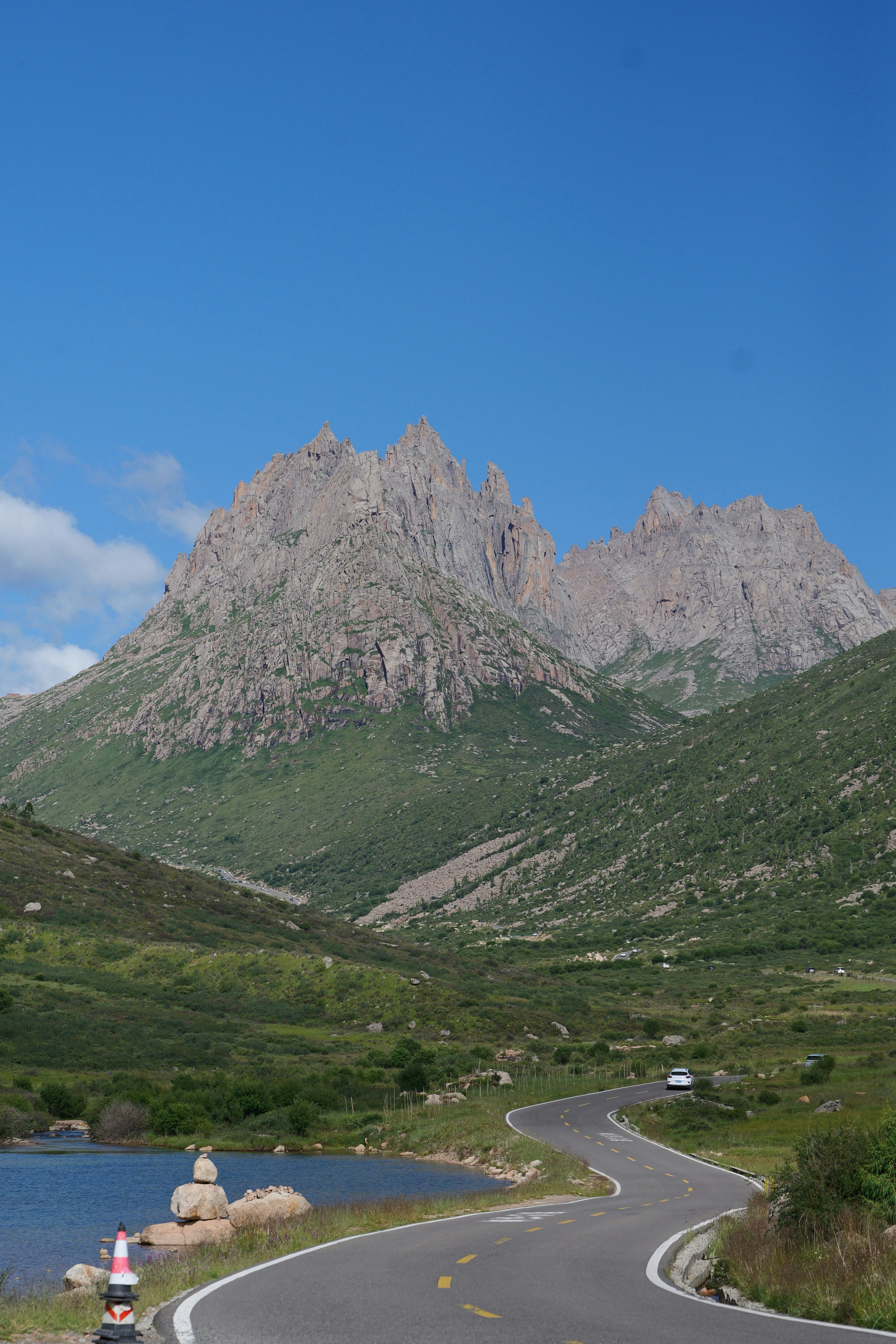 Azure Skies Over Winding Mountain Pass