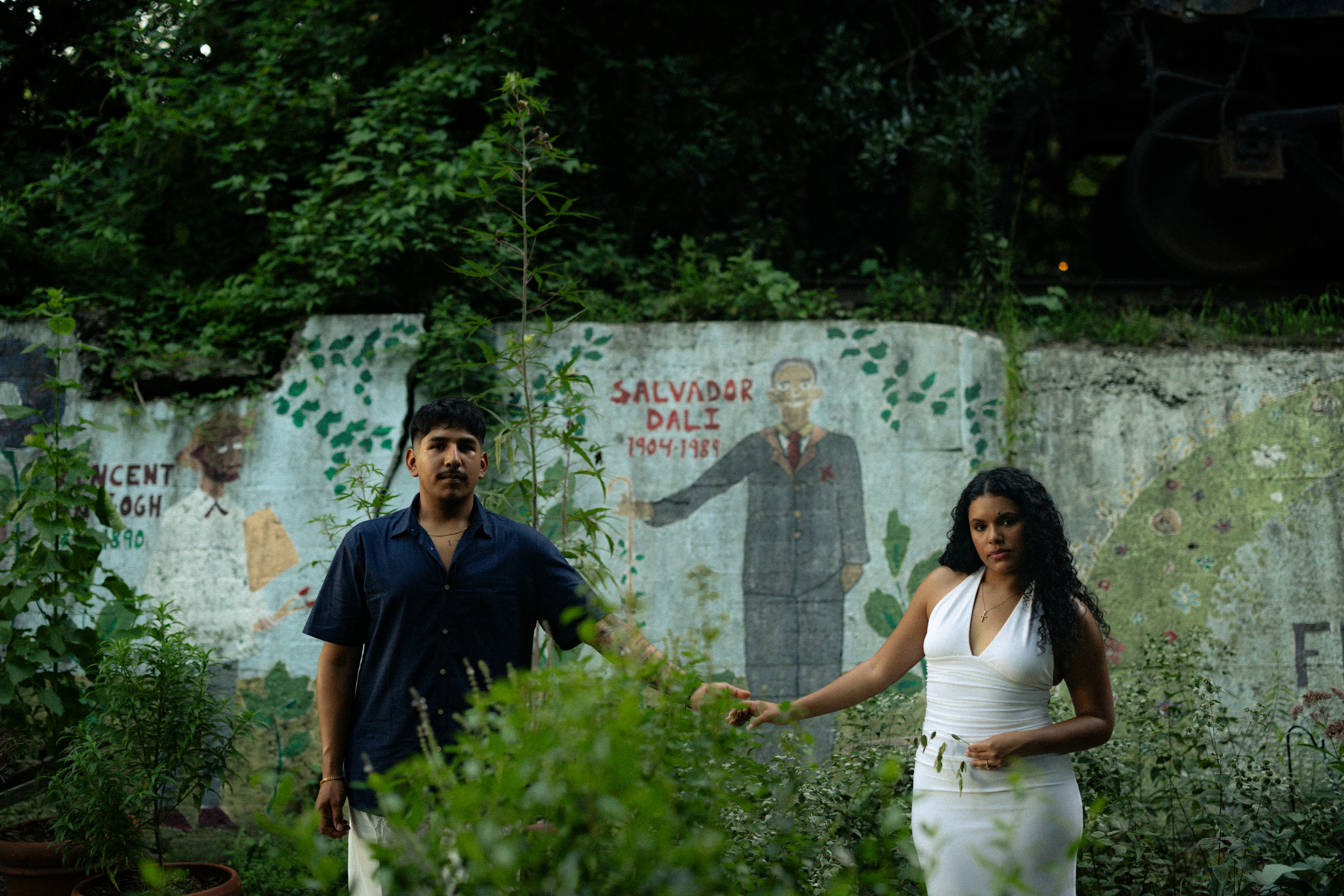 Two Figures in a Sunlit Alley: Quiet Resolve by the Graffiti Wall