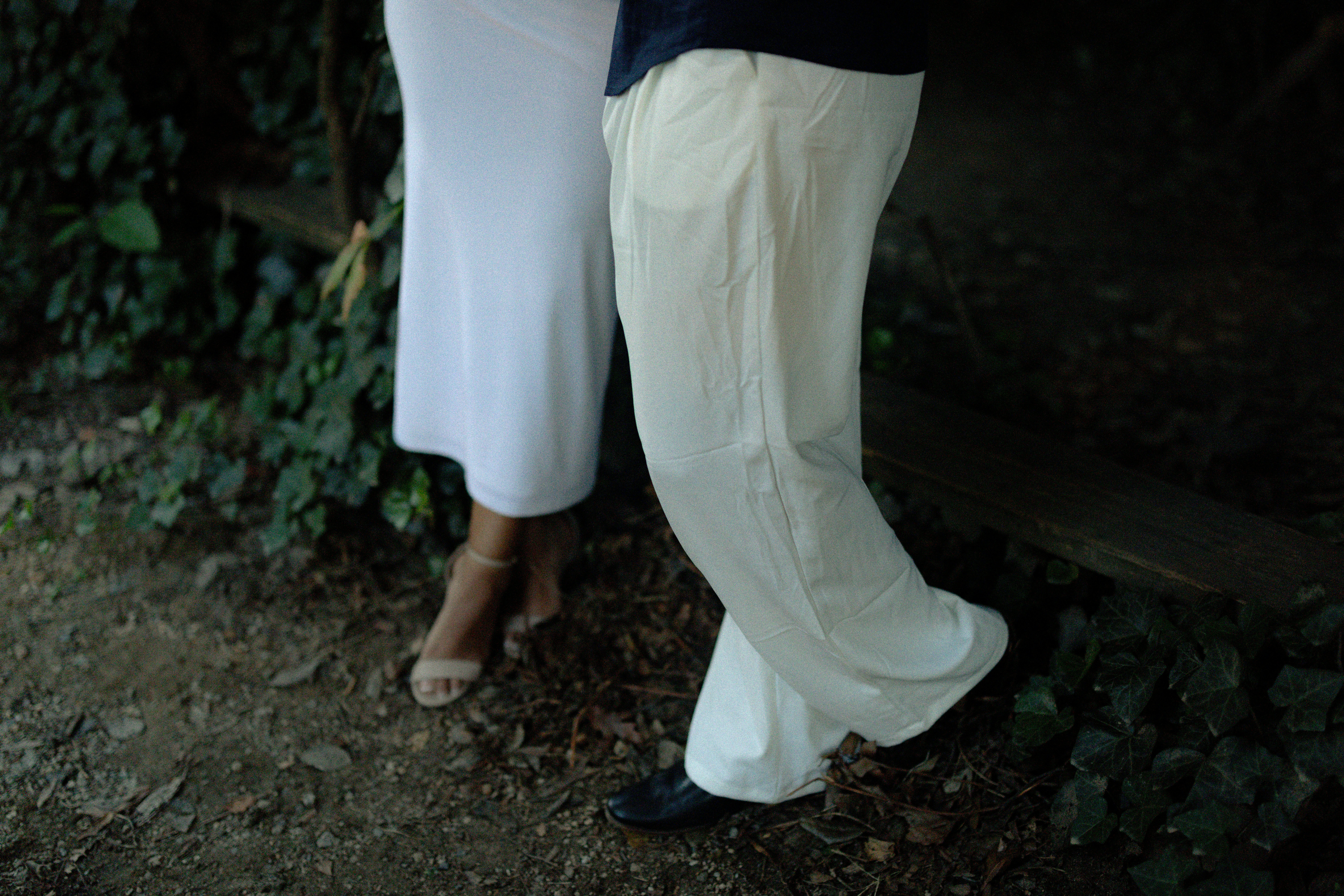 Two-step stroll: contrasting pants and shoes near a garden edge