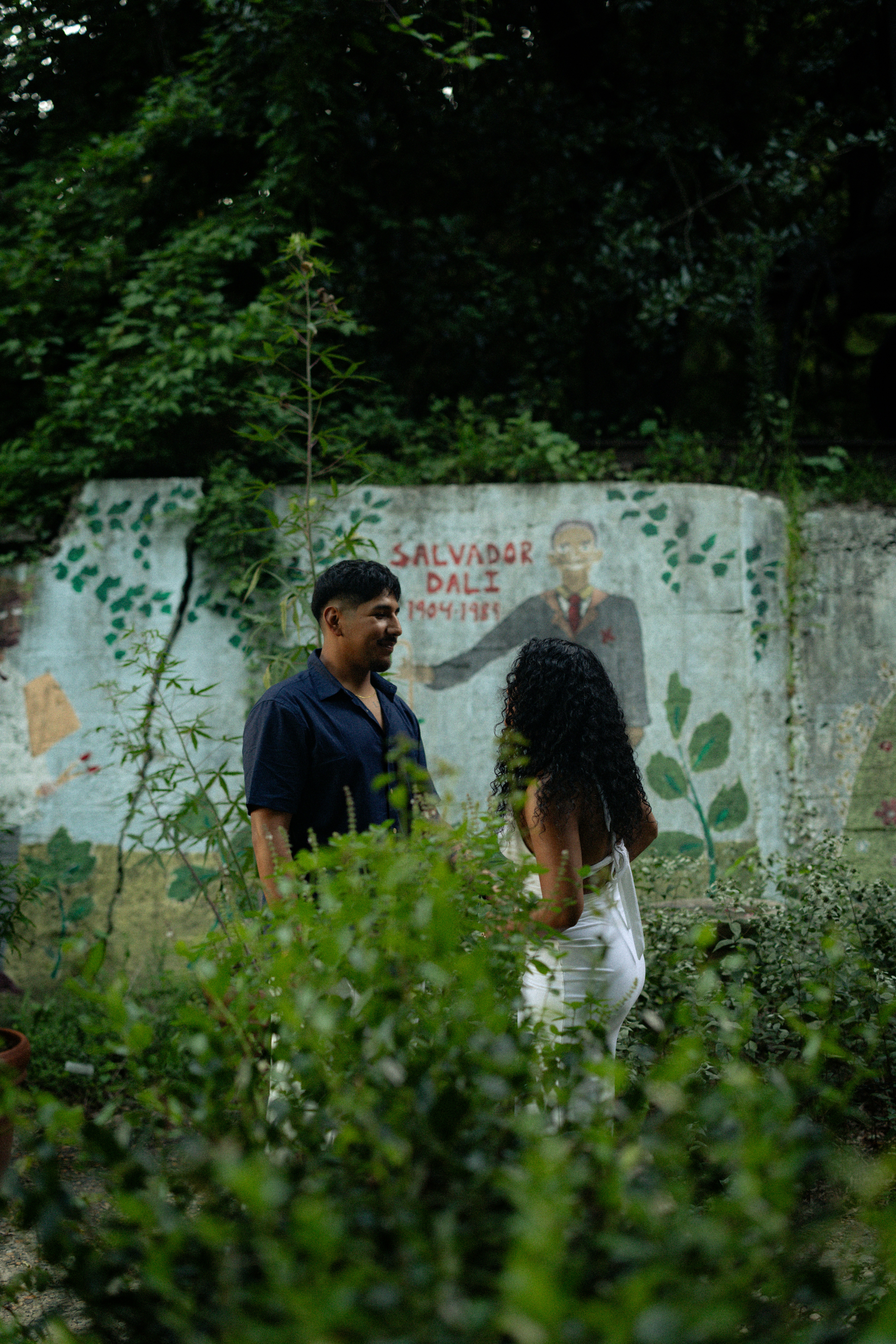 Quiet Exchange in a Green Wall Portrait