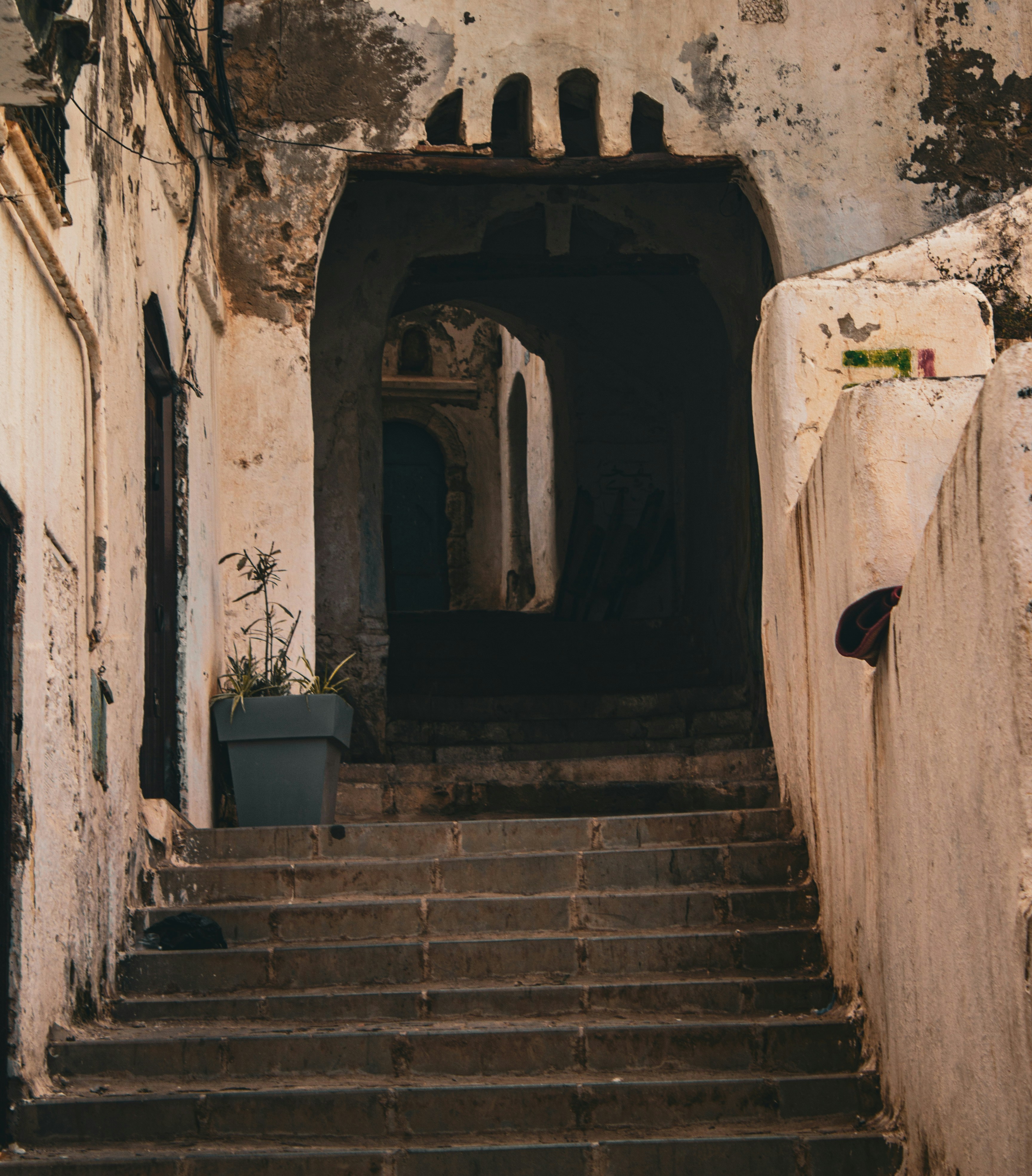 Steps into a shadowed archway: a passage through time