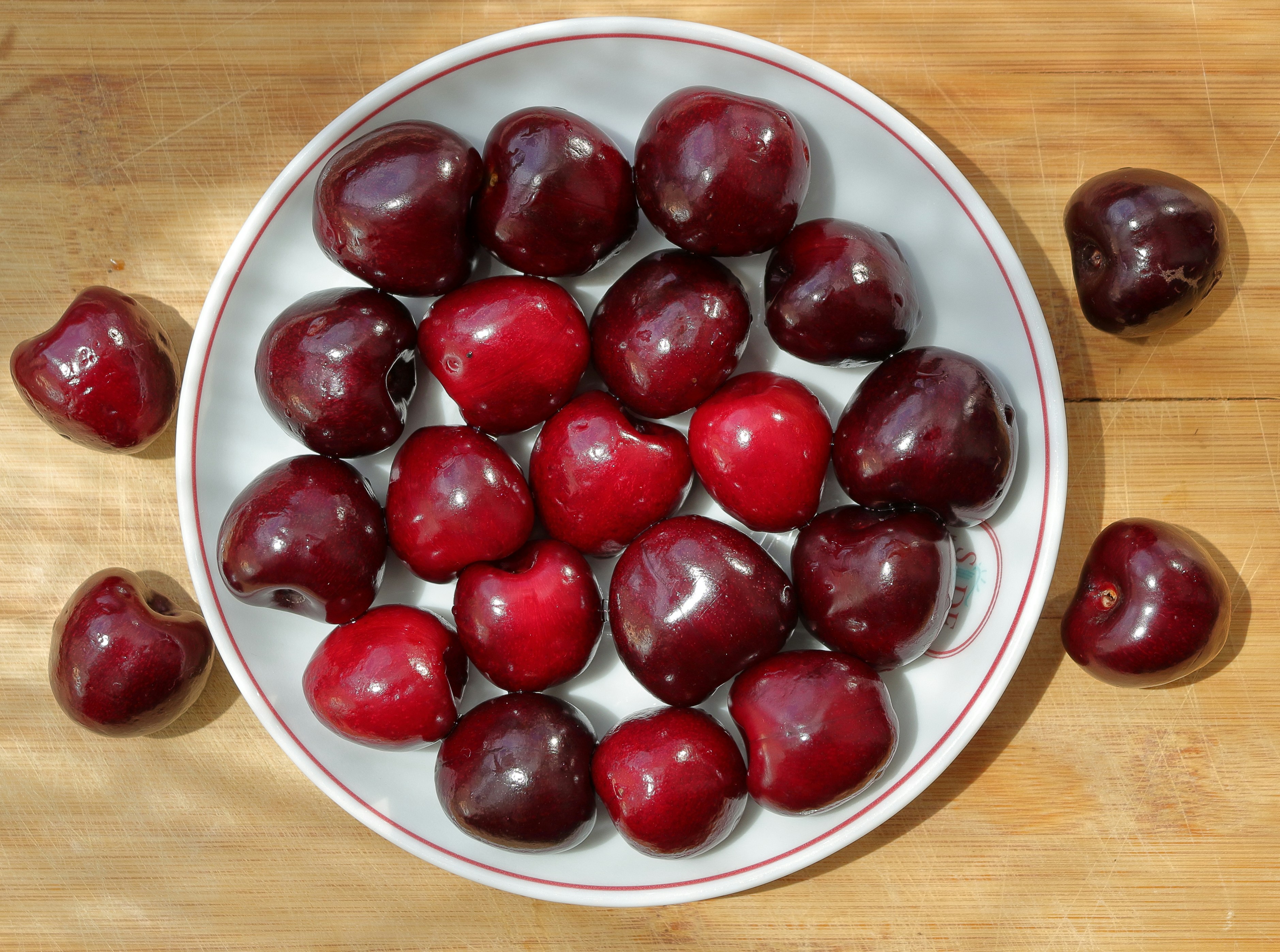 Red Delights in a White Rimmed Bowl: A Cherry-Centered Still Life