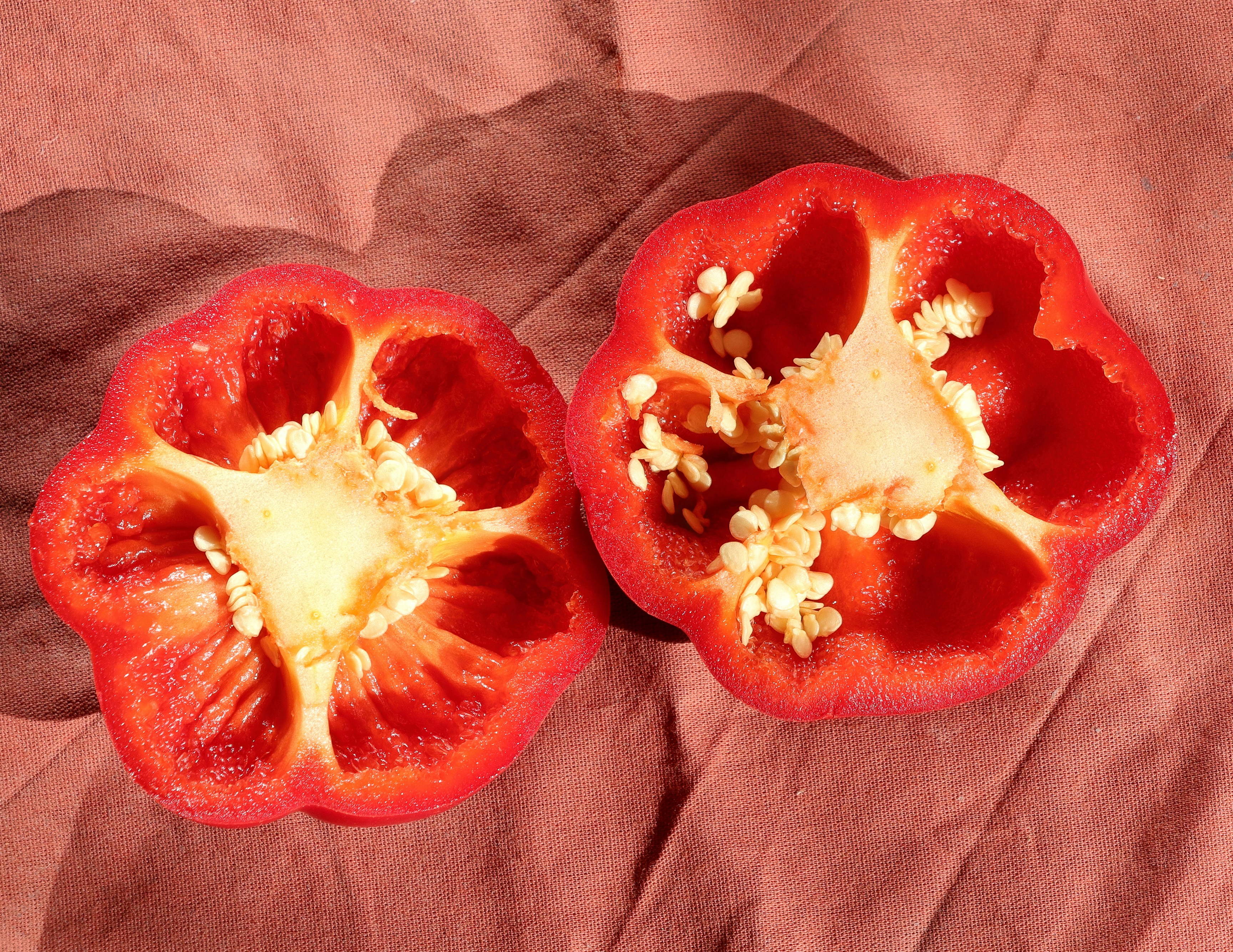 Split Red Pepper Halves Resting on a Velvet-like Surface