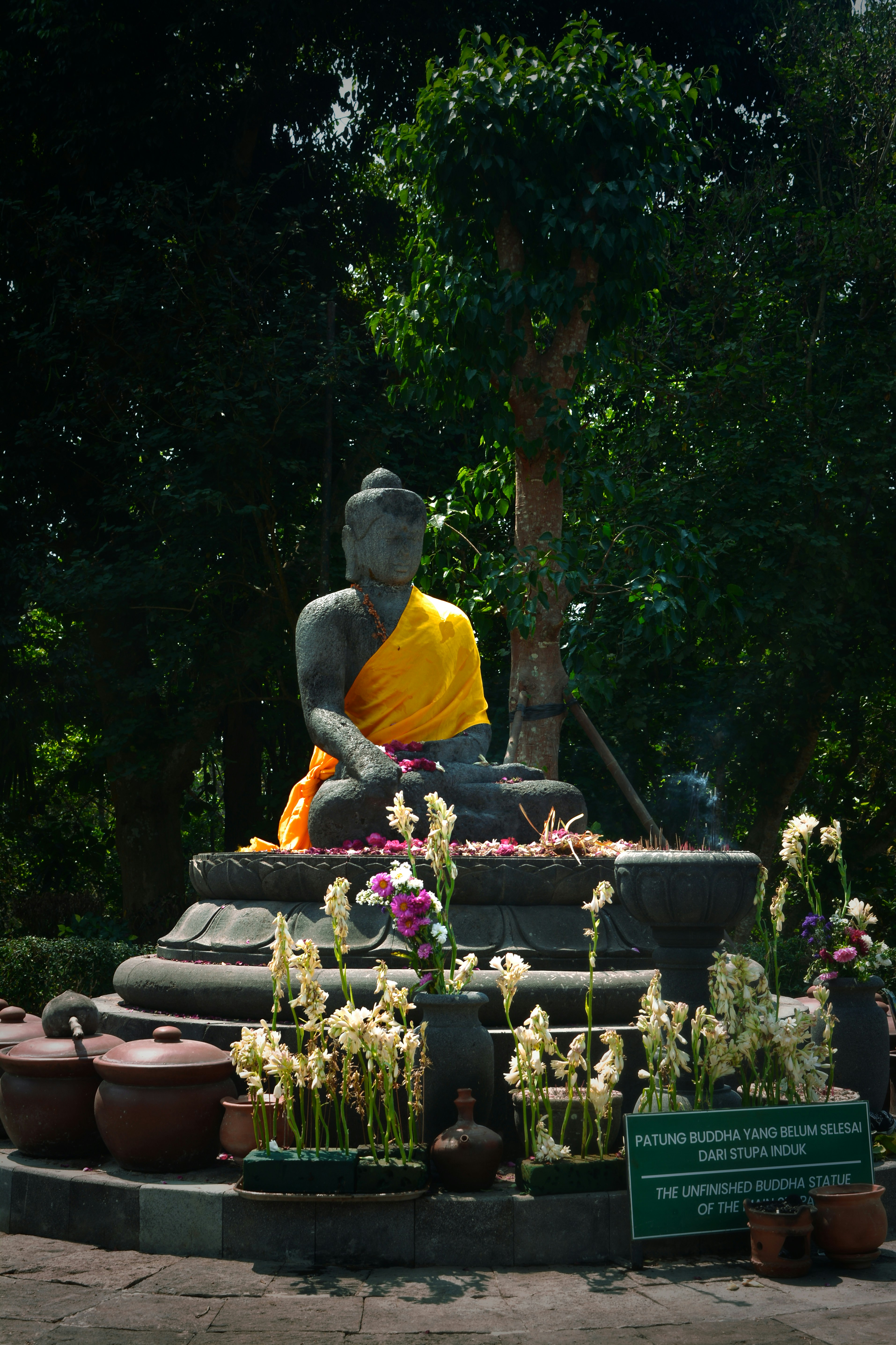 Serene Buddha with Golden Drapery Amid Floral Offerings