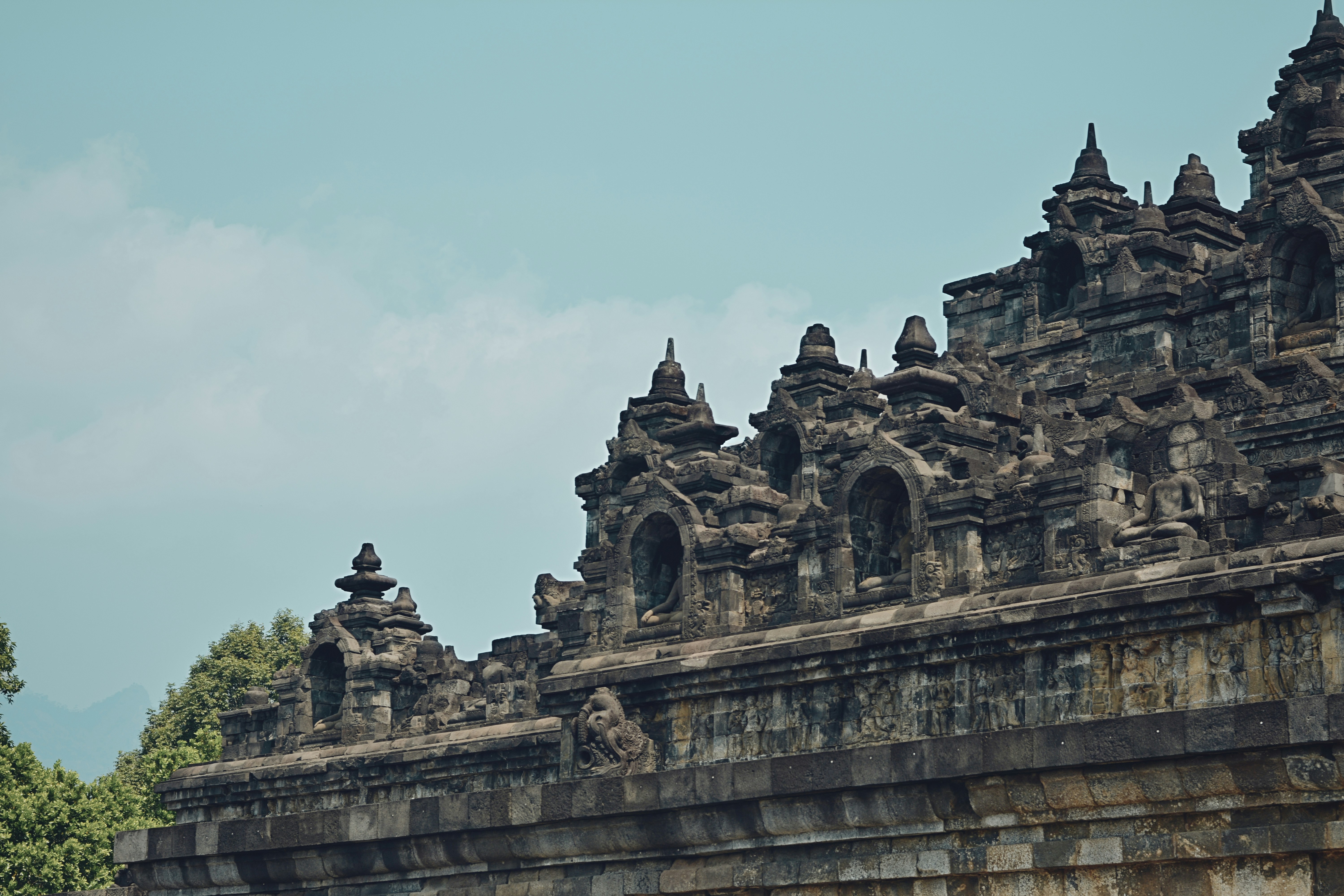 Stone Carved Panorama: Ancient Roofline Against Clear Sky
