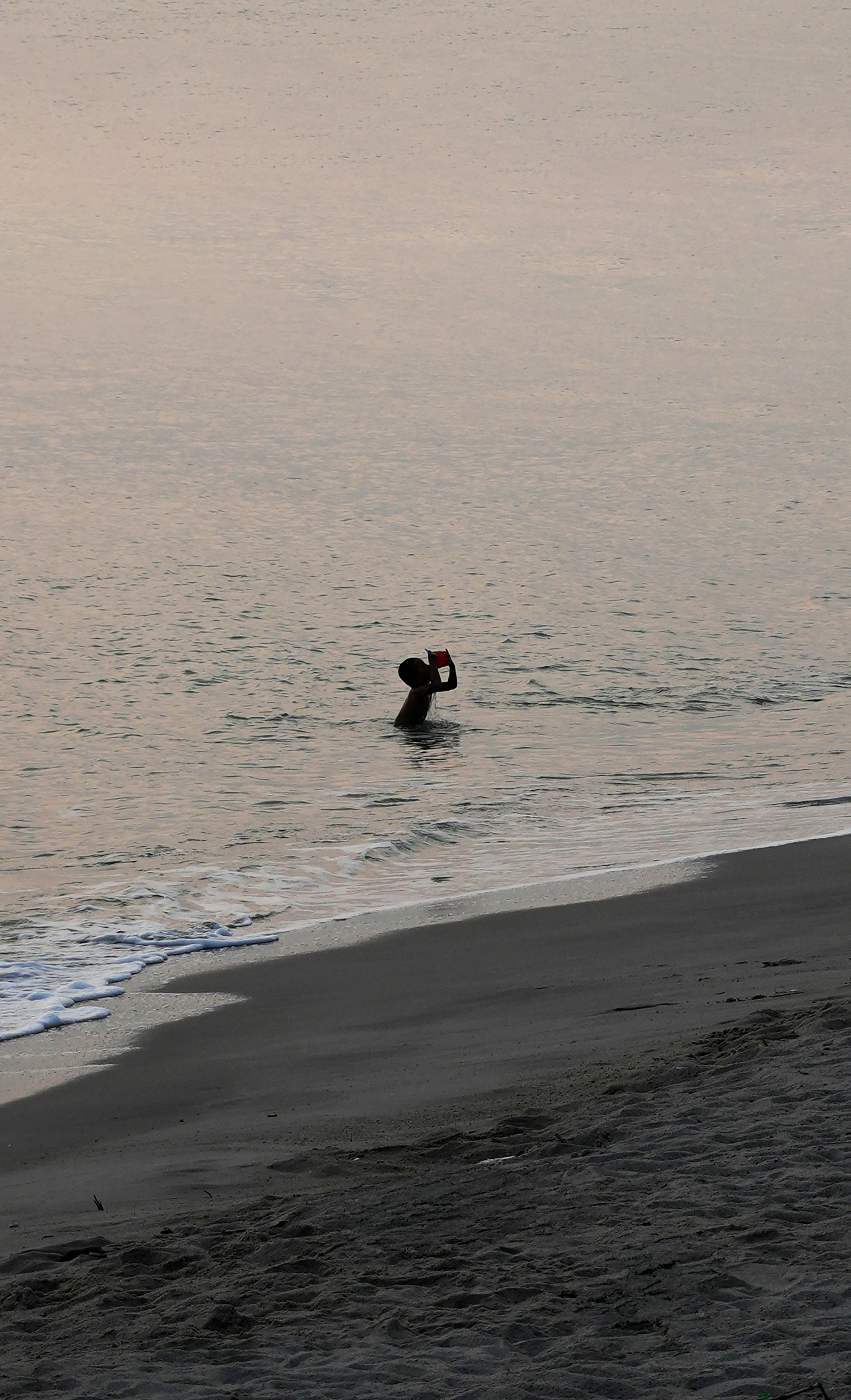 Silhouette with a Red Book: Quiet Shoreline Moment