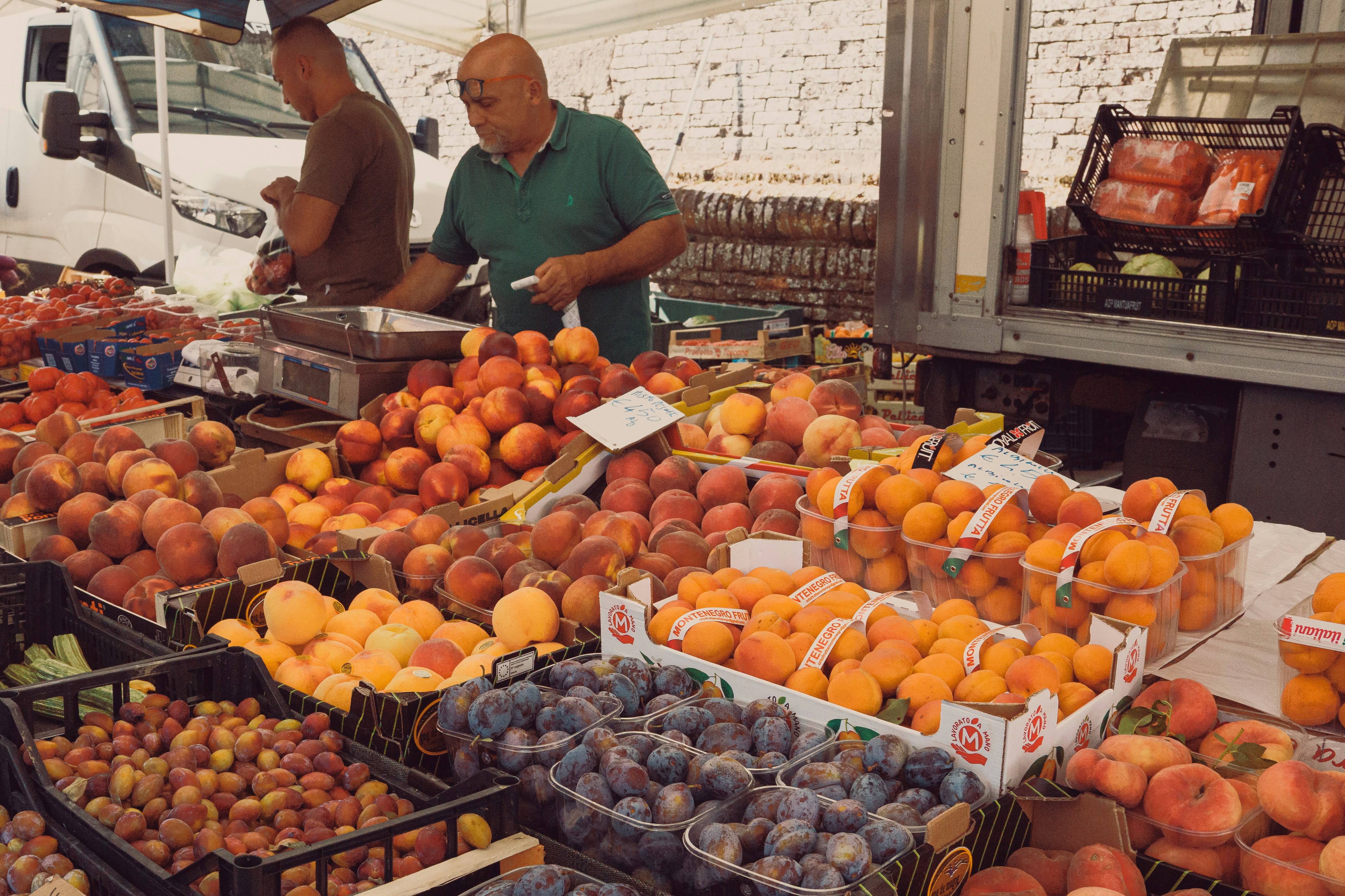Market Hands: Fresh Fruit Stand Beneath a Sunlit Tent
