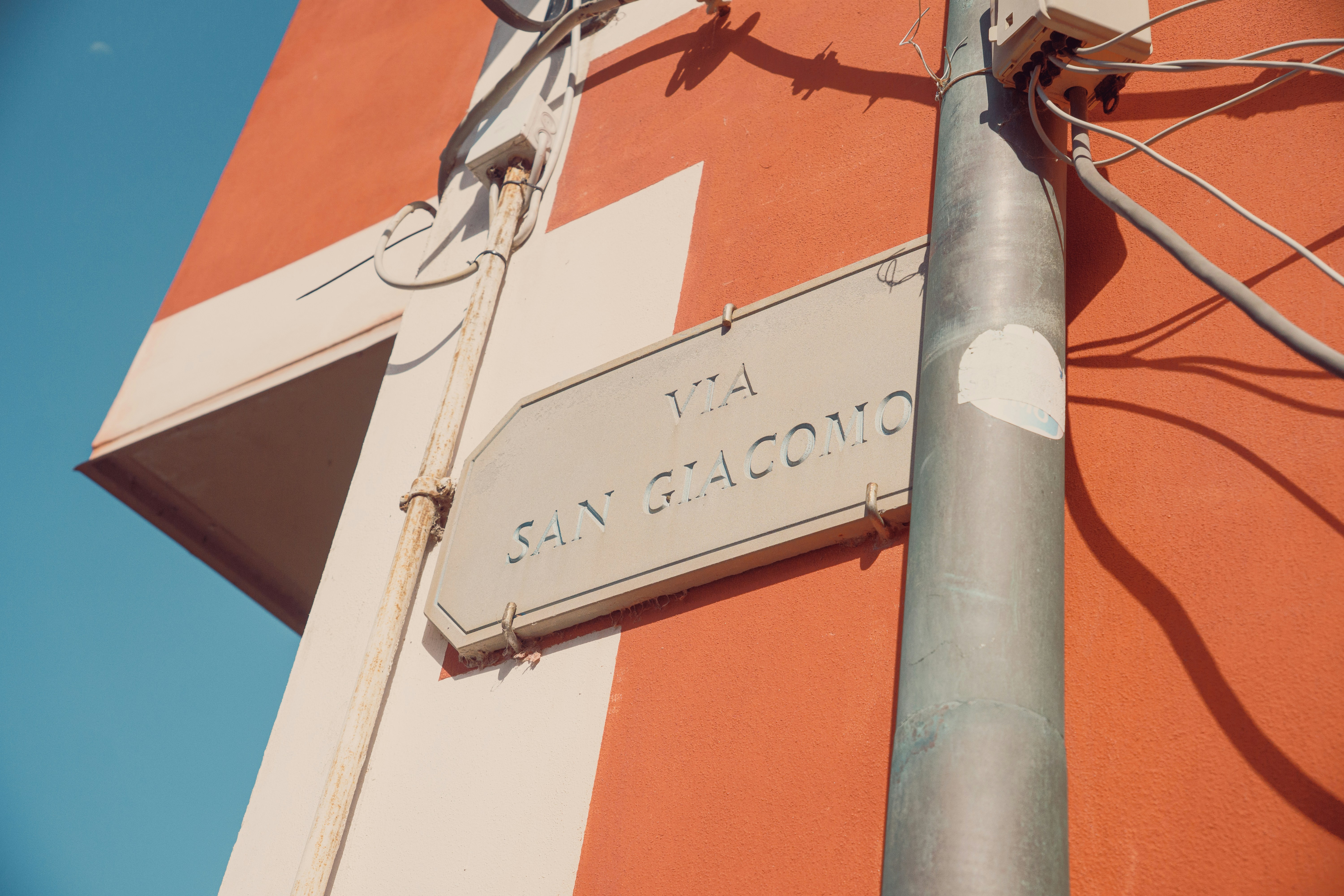 San Telmo Post: Weathered Sign on a Sunlit Corner