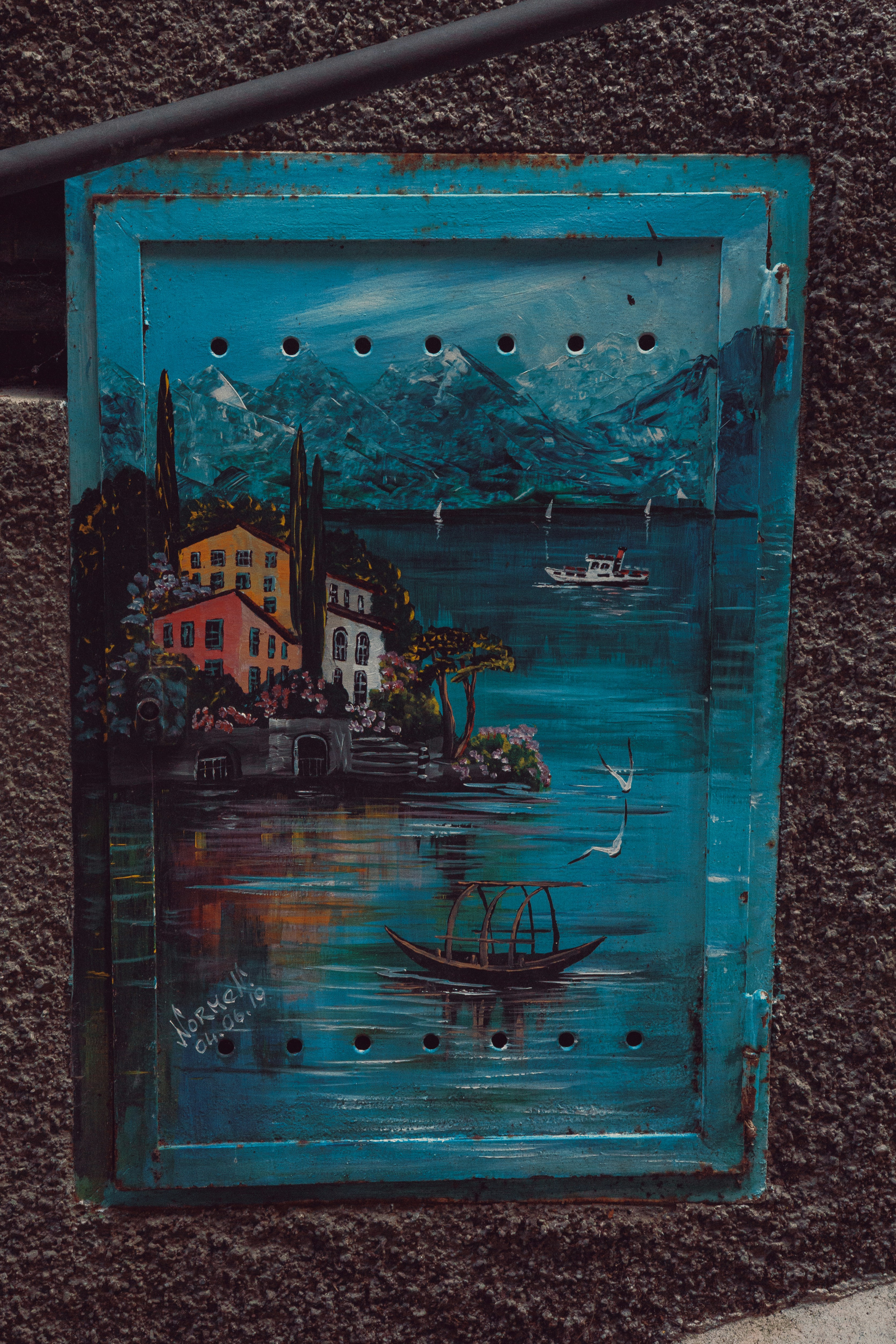 Blue Portico: A Coastal Mural Framed by Rough Stone