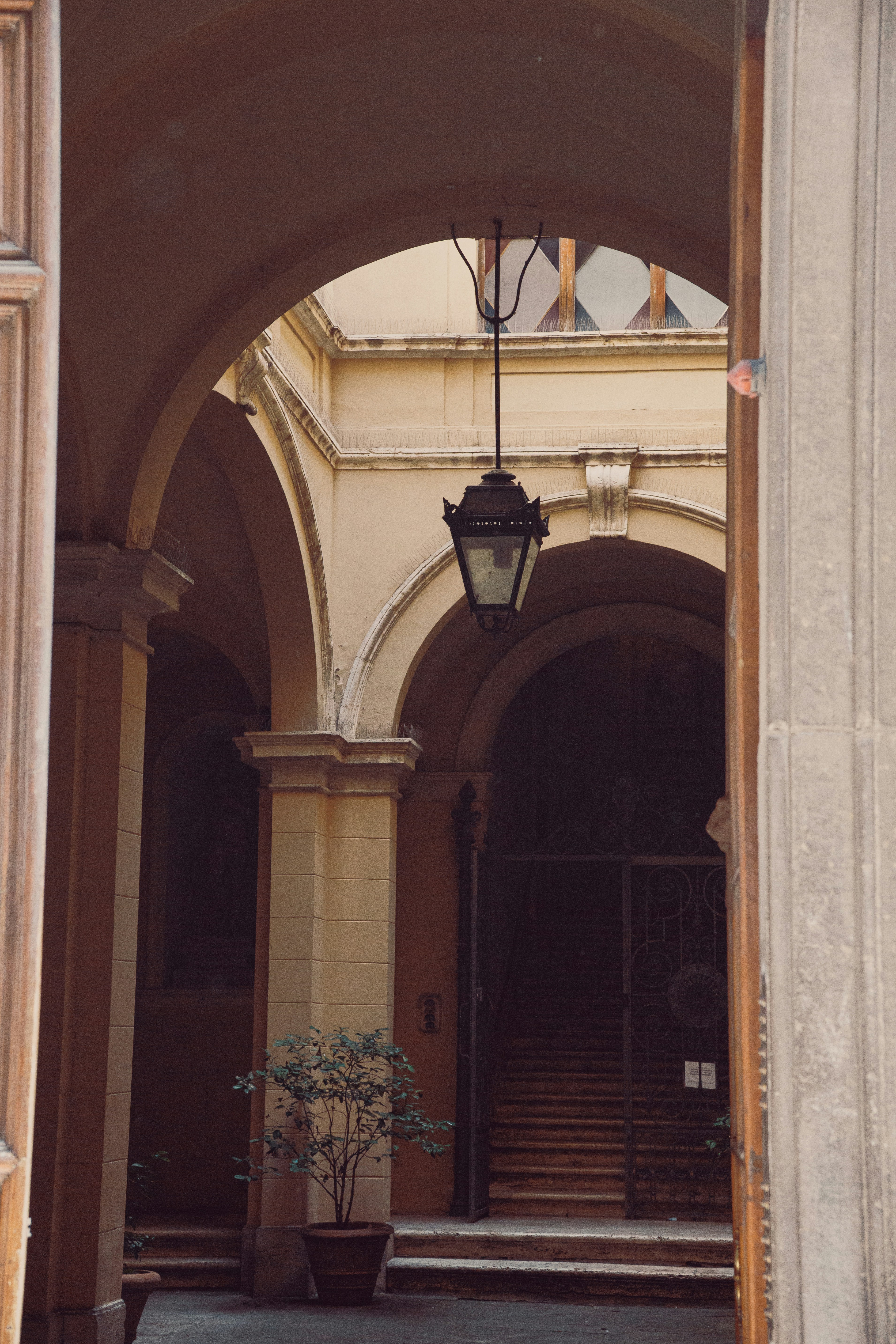 Archway Symphony: Lantern Over a Sunlit Courtyard